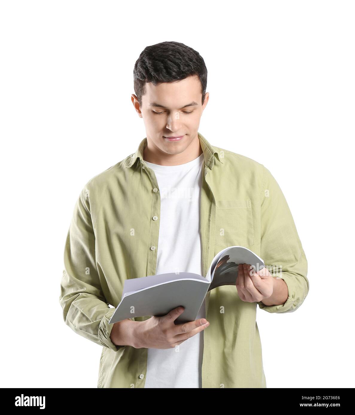 Handsome young man reading magazine on white background Stock Photo - Alamy