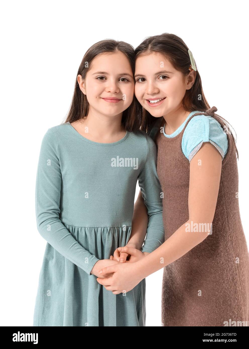 Cute twin girls on white background Stock Photo - Alamy