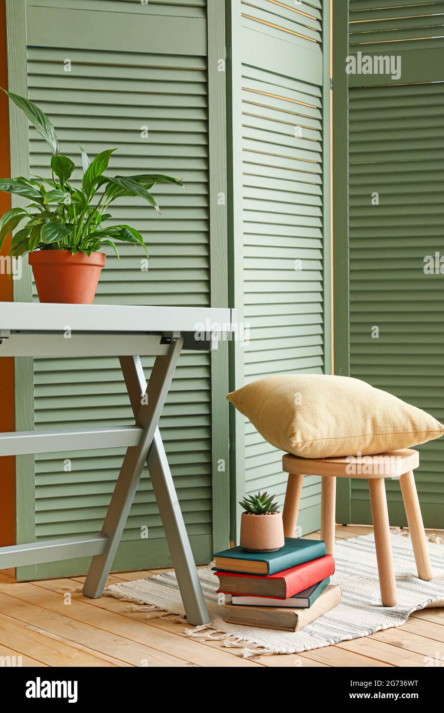 Interior of stylish room with folding screen Stock Photo - Alamy