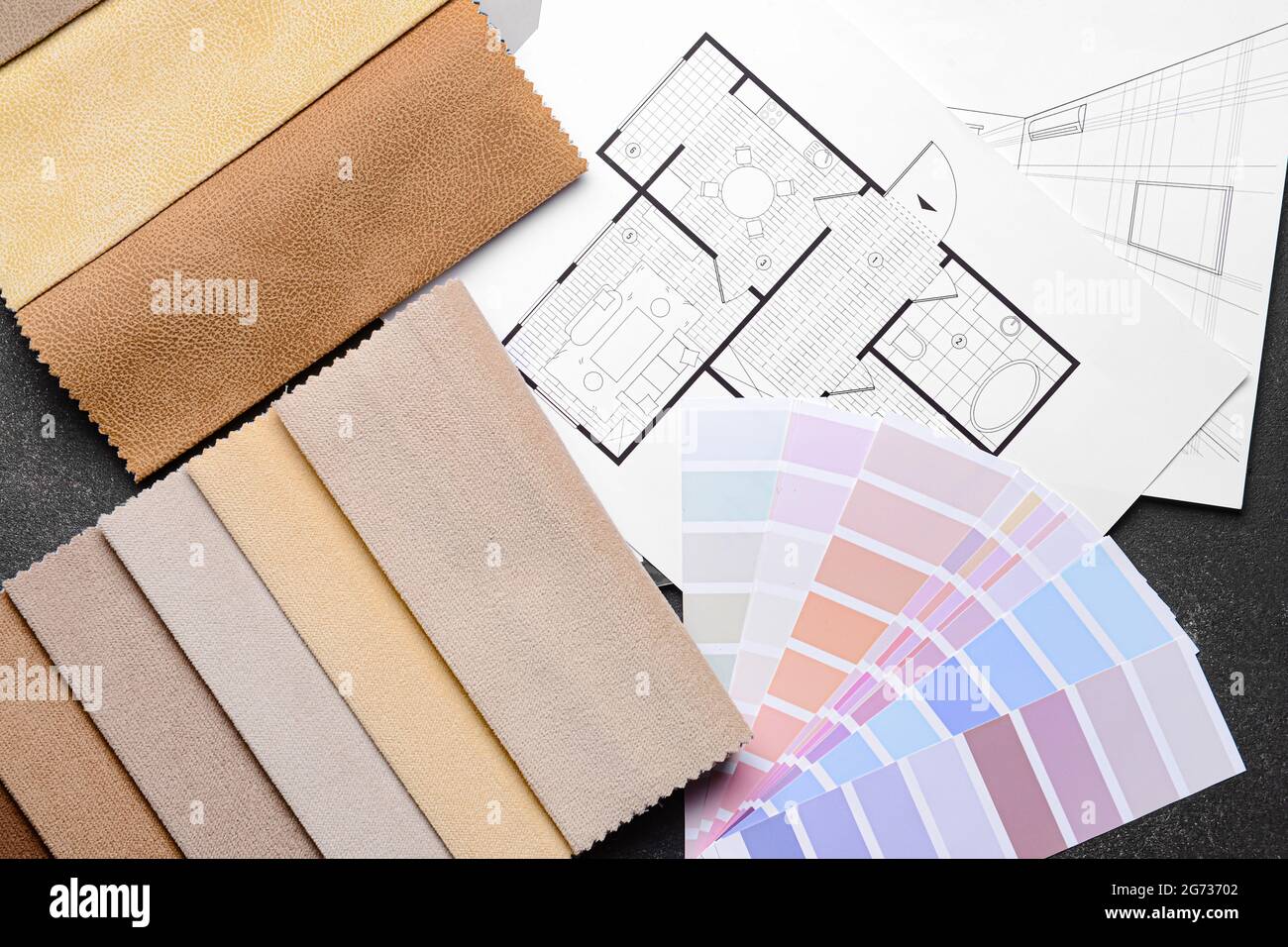 Composition with paint color palettes and fabric samples on dark ...