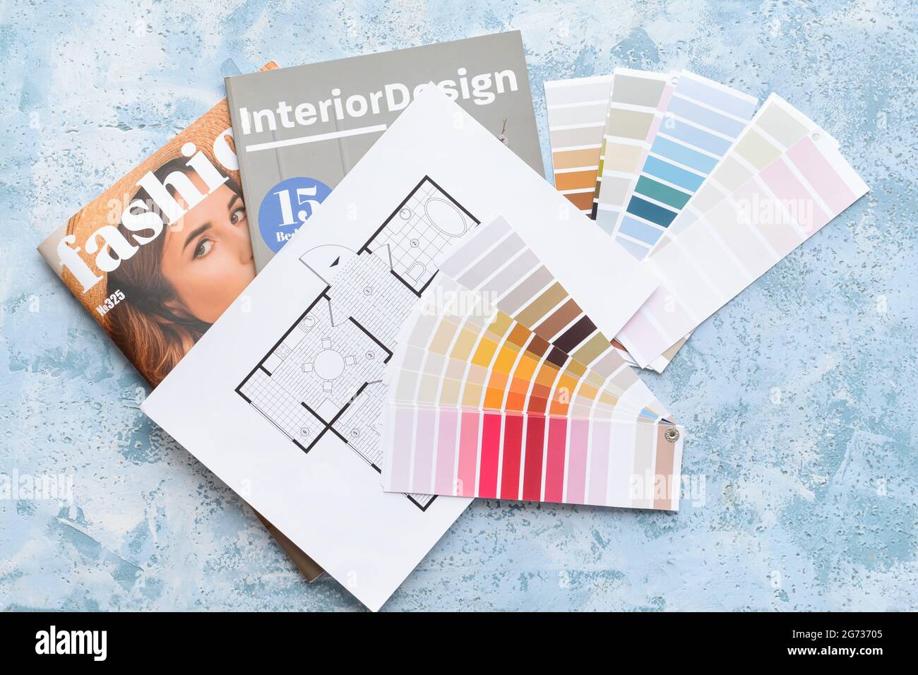 Paint color samples with house plan and magazines on color background ...
