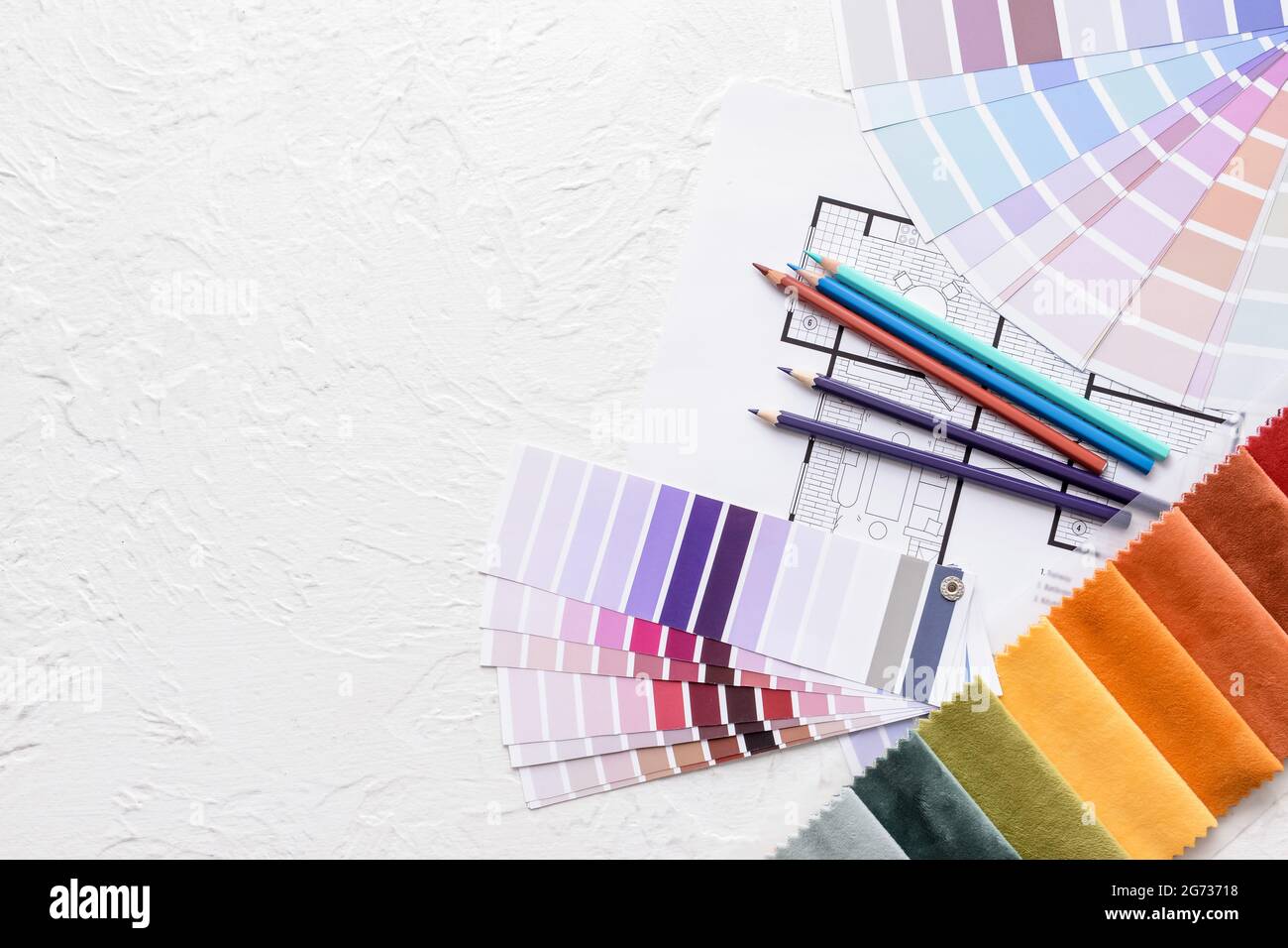 Composition with paint color palettes and fabric samples on white ...