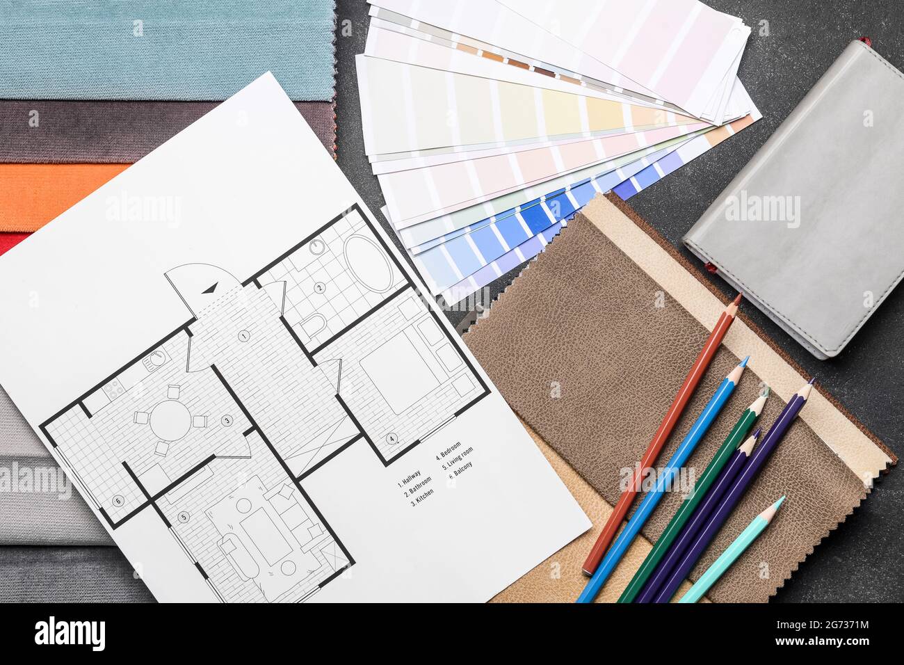 Composition with paint color palettes and house plan on dark background ...