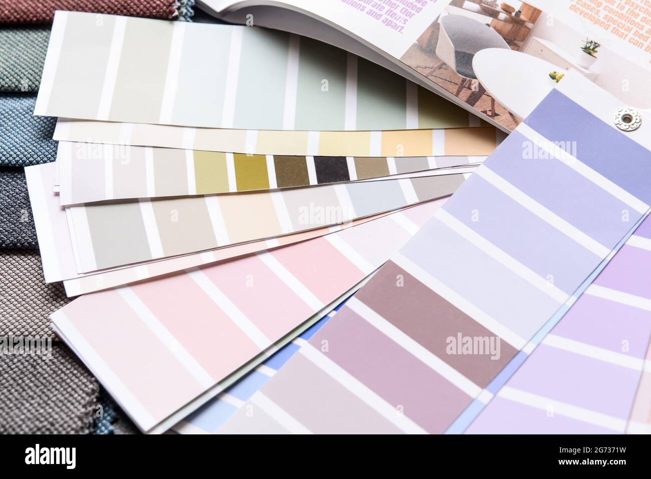 Paint color palettes with fabric samples and magazine, closeup Stock ...