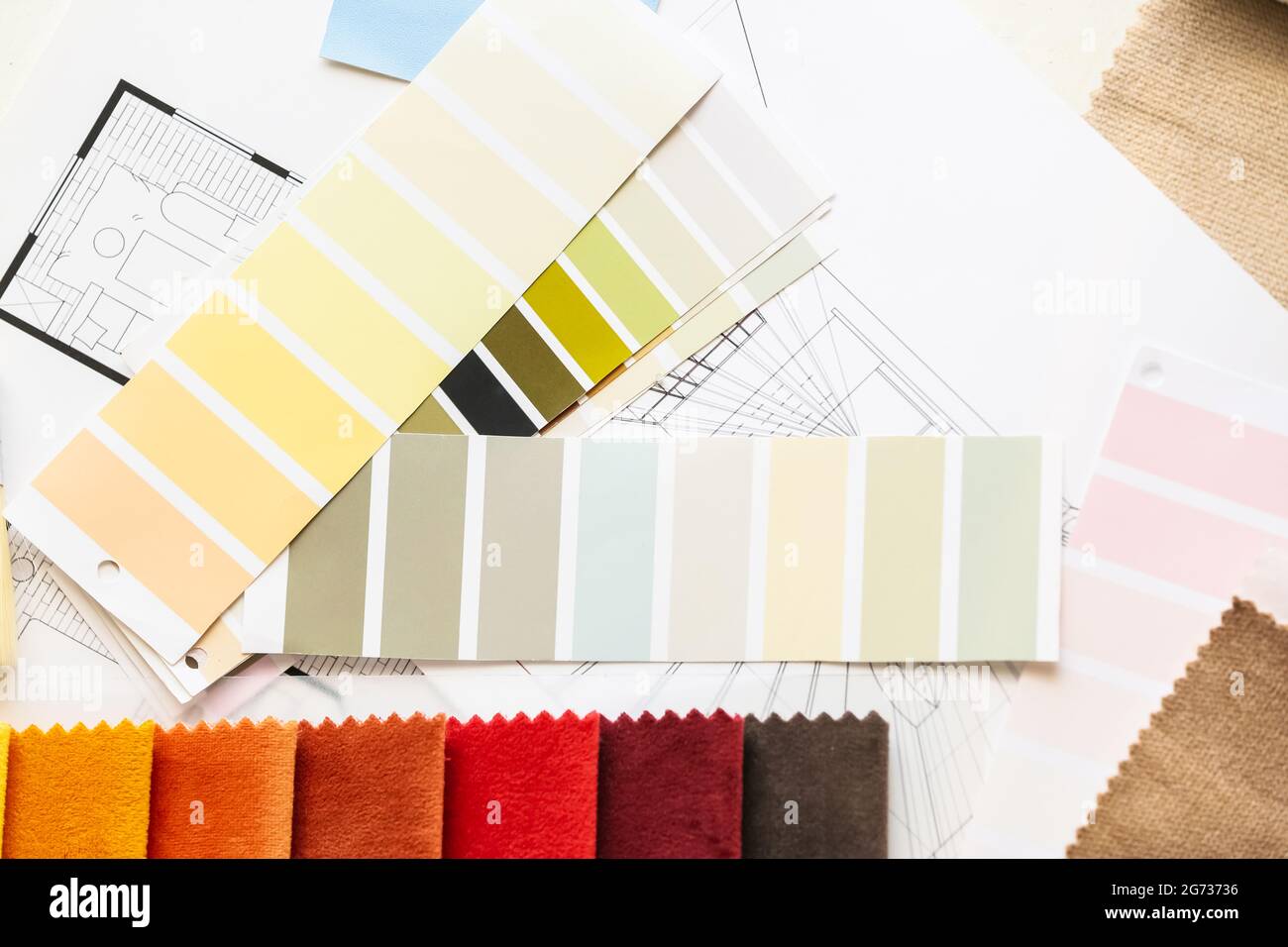 Composition with paint color palettes and fabric samples on light ...