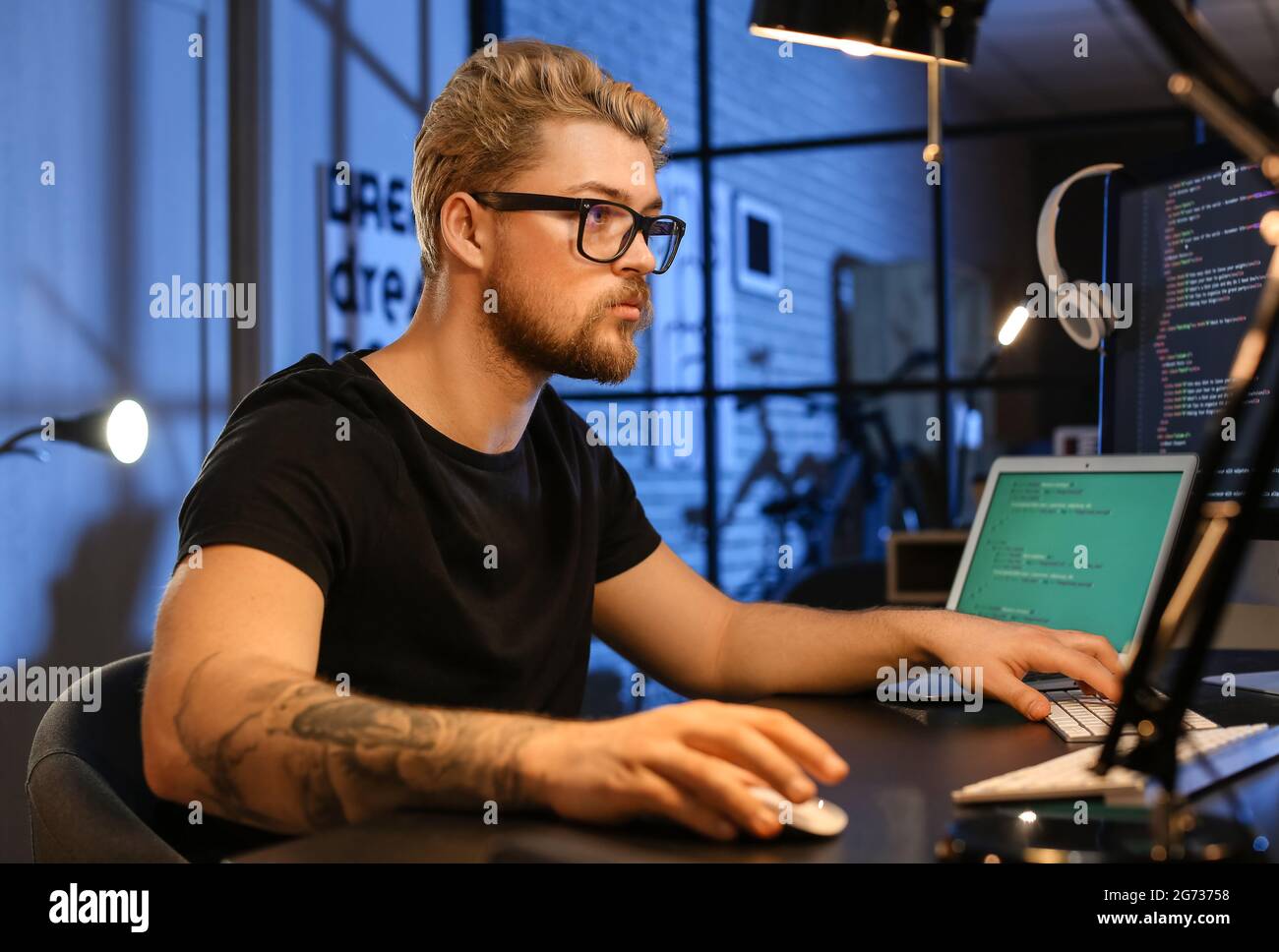 Male programmer working with computer late in evening Stock Photo - Alamy