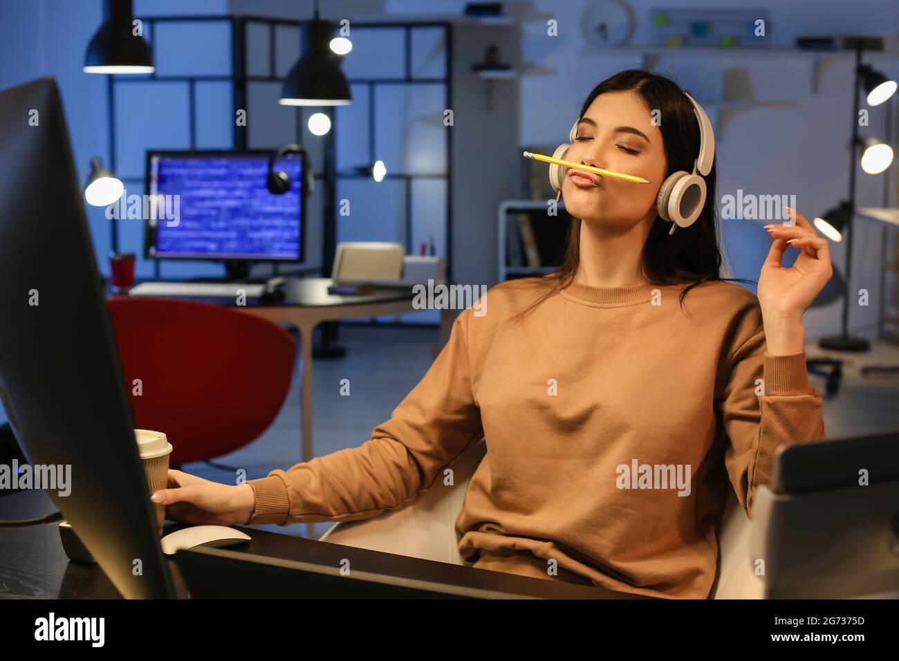 Female programmer having fun in office at night Stock Photo - Alamy