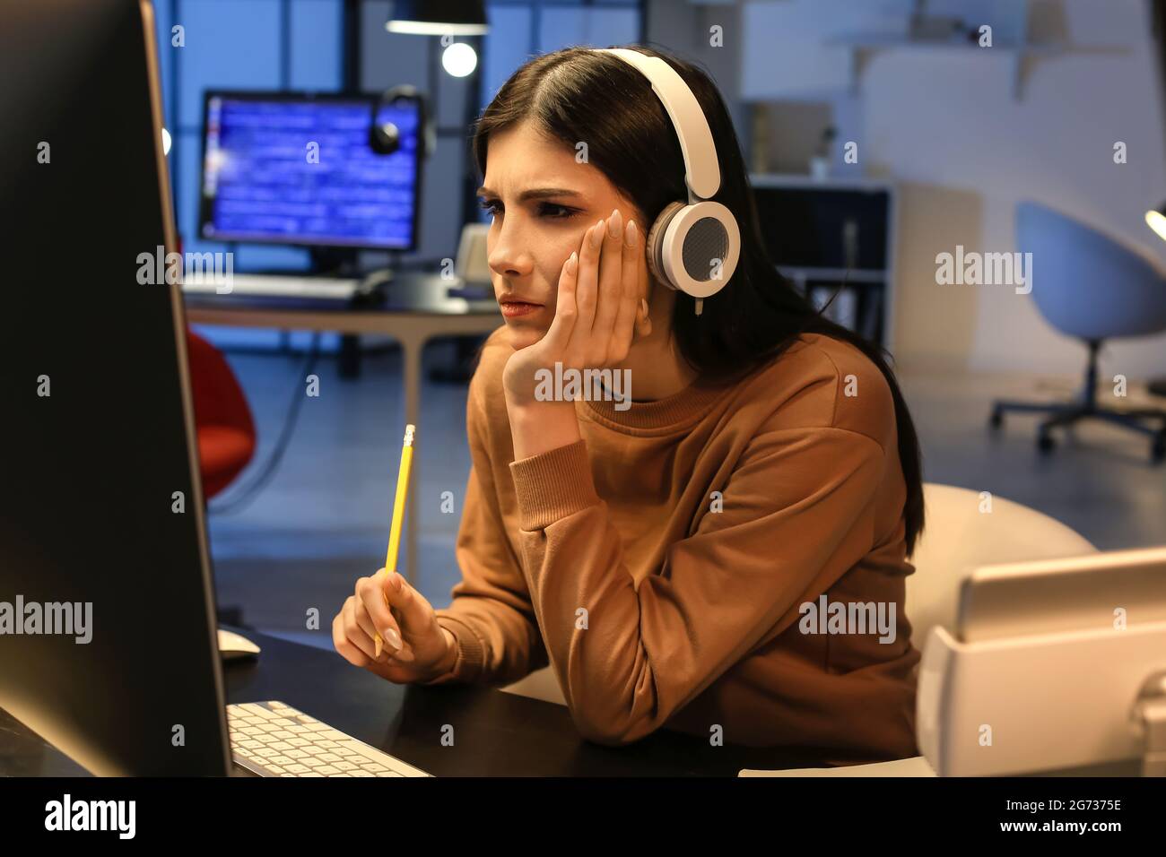 Female programmer working with computer late in evening Stock Photo - Alamy