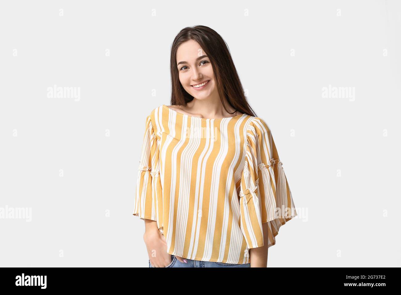Beautiful young woman on light background Stock Photo - Alamy