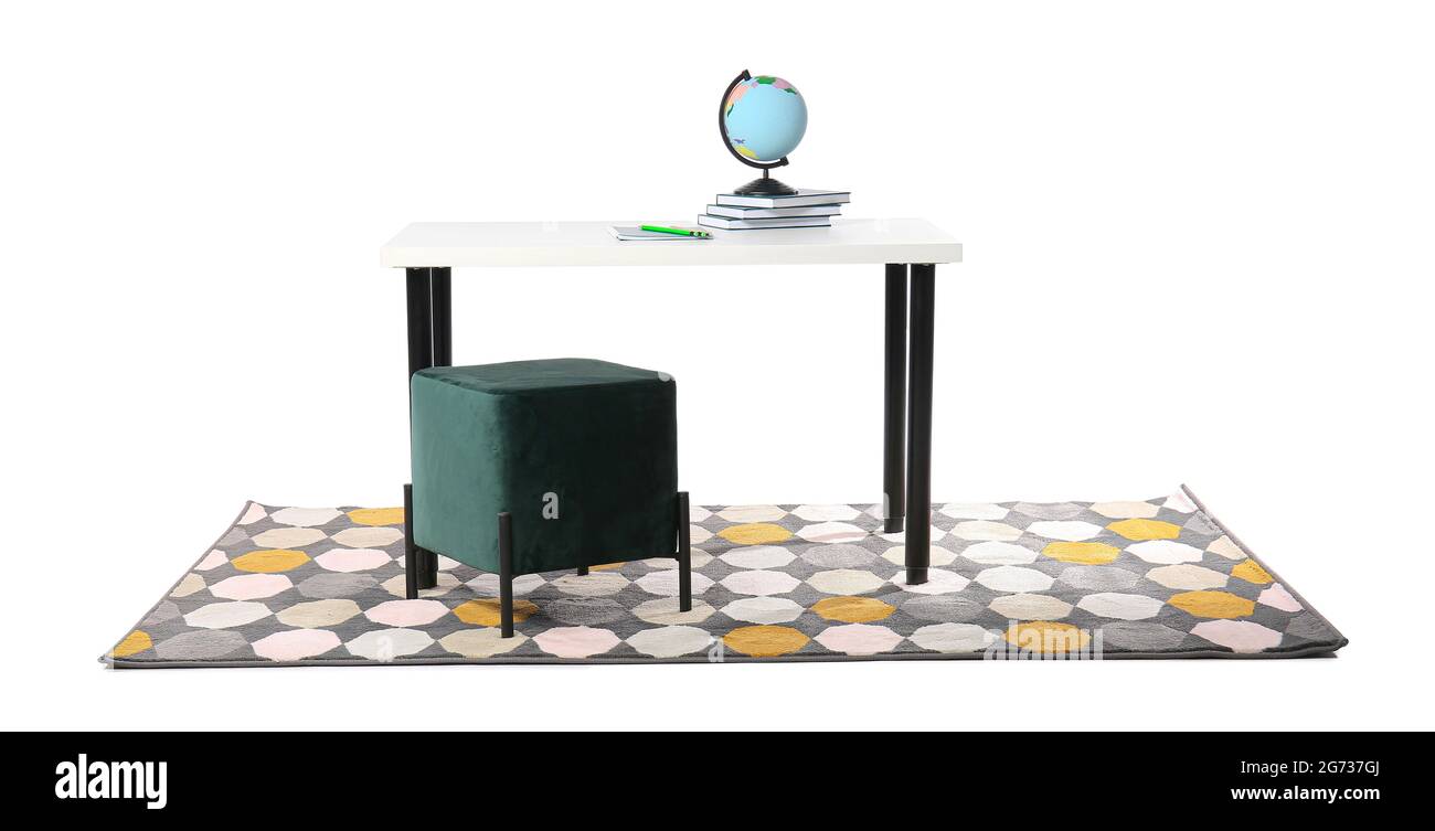 Stylish table, pouf and rug on white background Stock Photo - Alamy