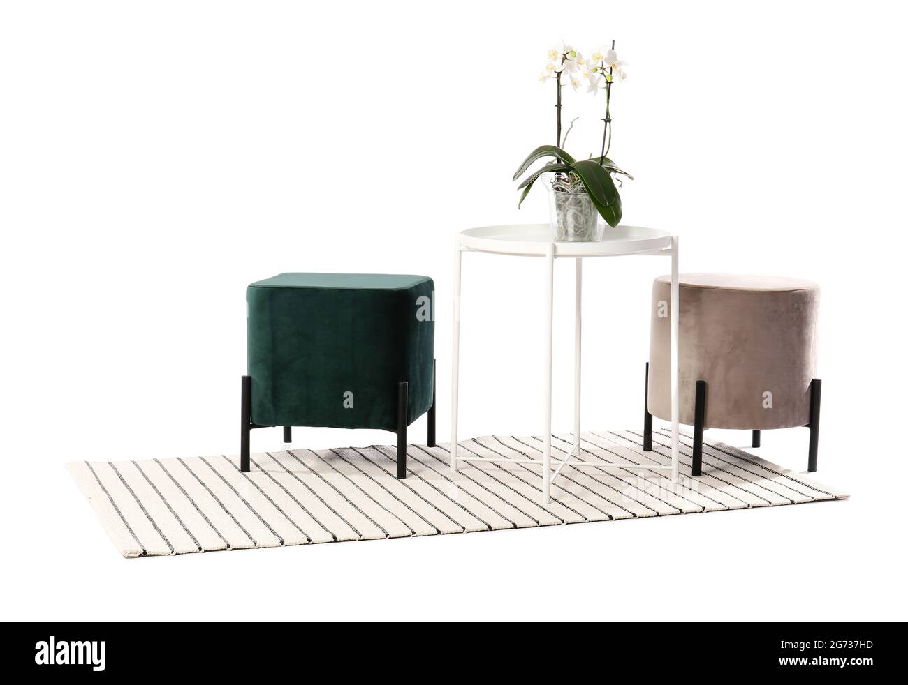 Table with poufs and rug on white background Stock Photo - Alamy