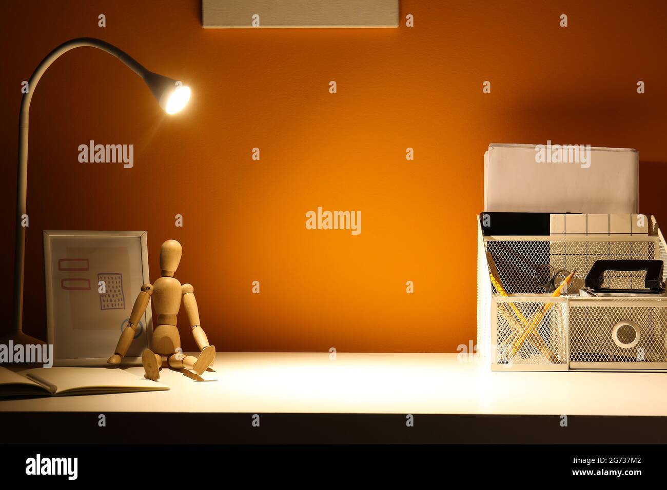 Modern workplace with organizer and glowing lamp in dark room Stock ...