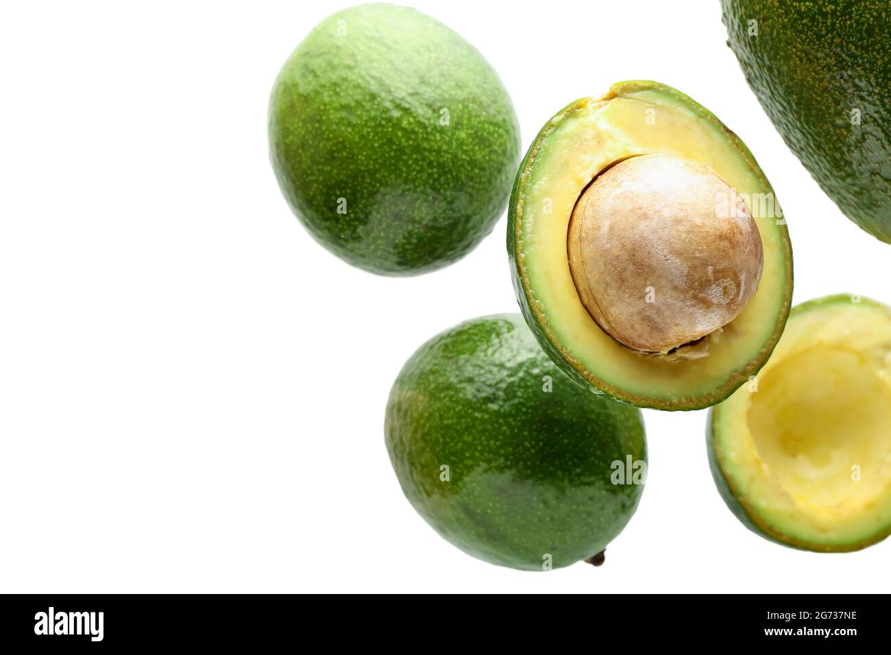 Flying avocados on white background Stock Photo - Alamy