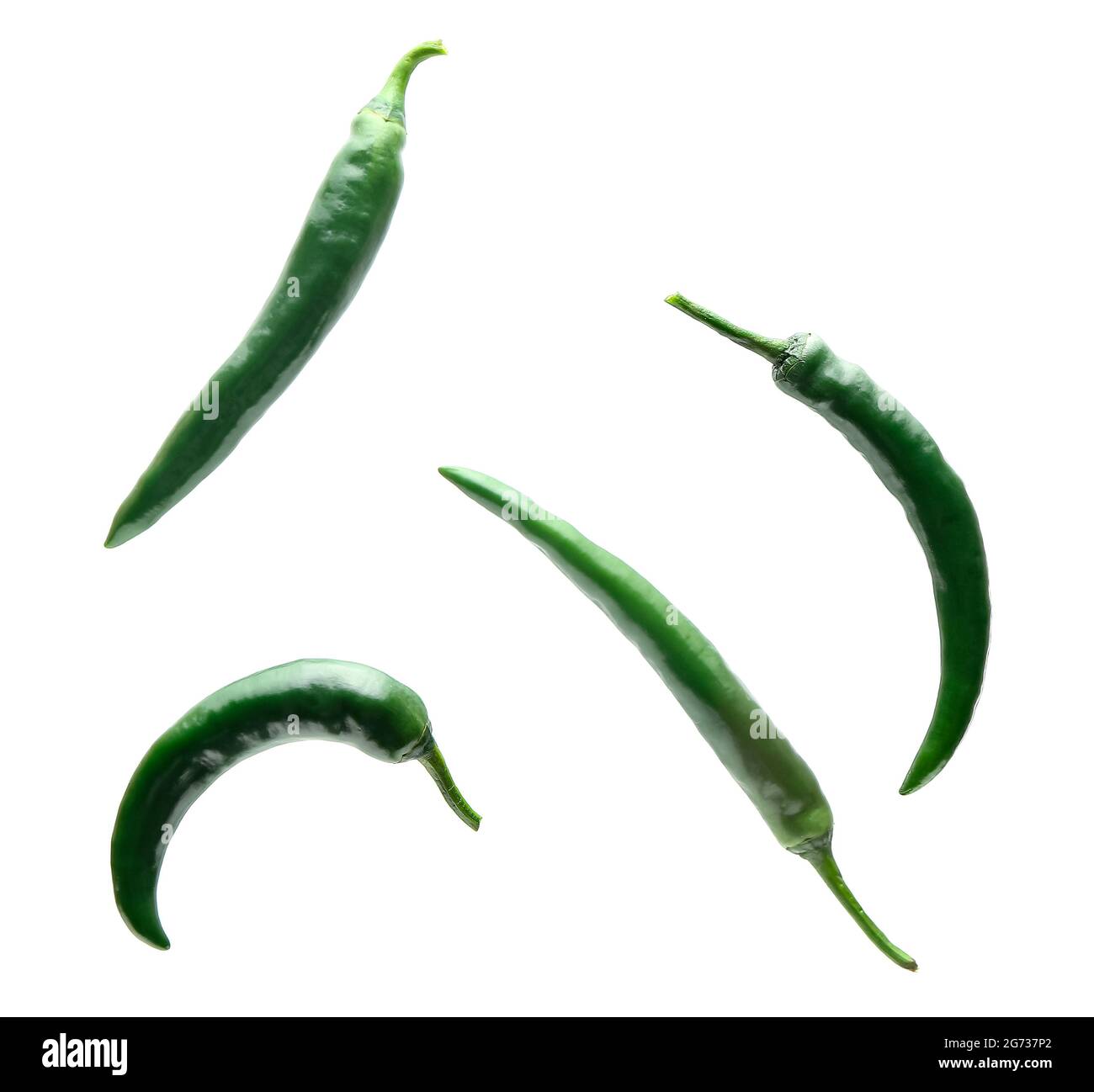 Flying chili peppers on white background Stock Photo - Alamy