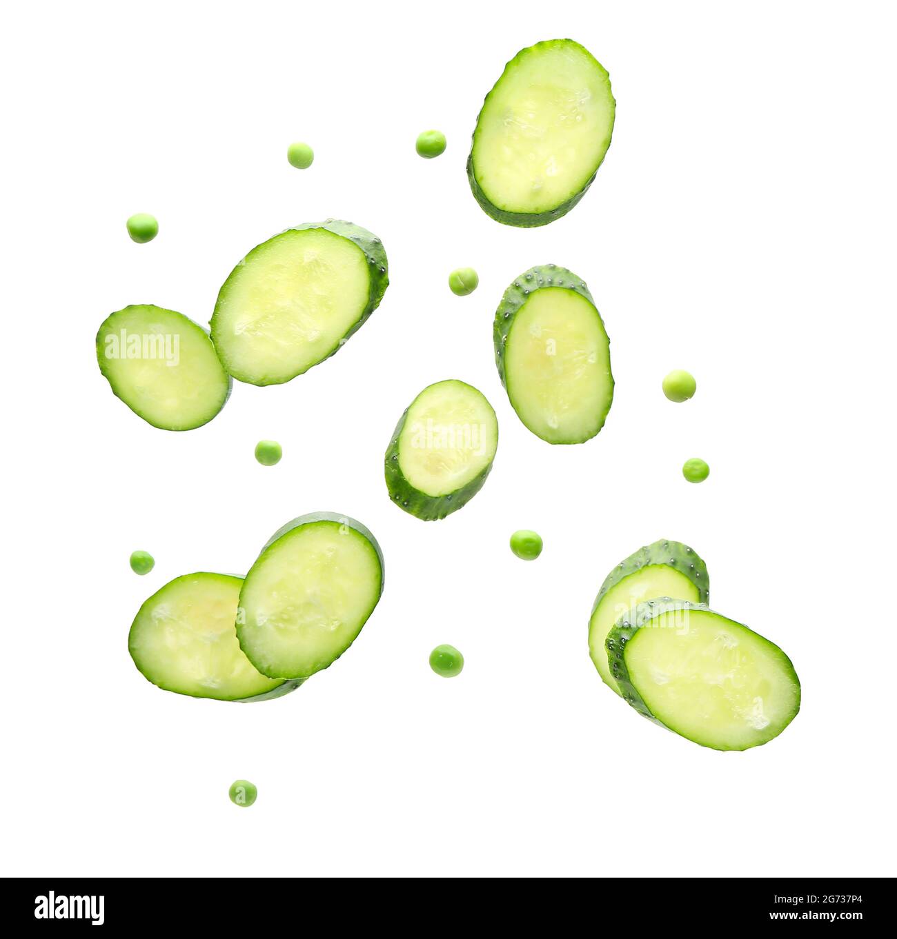 Flying cucumber slices and peas on white background Stock Photo - Alamy