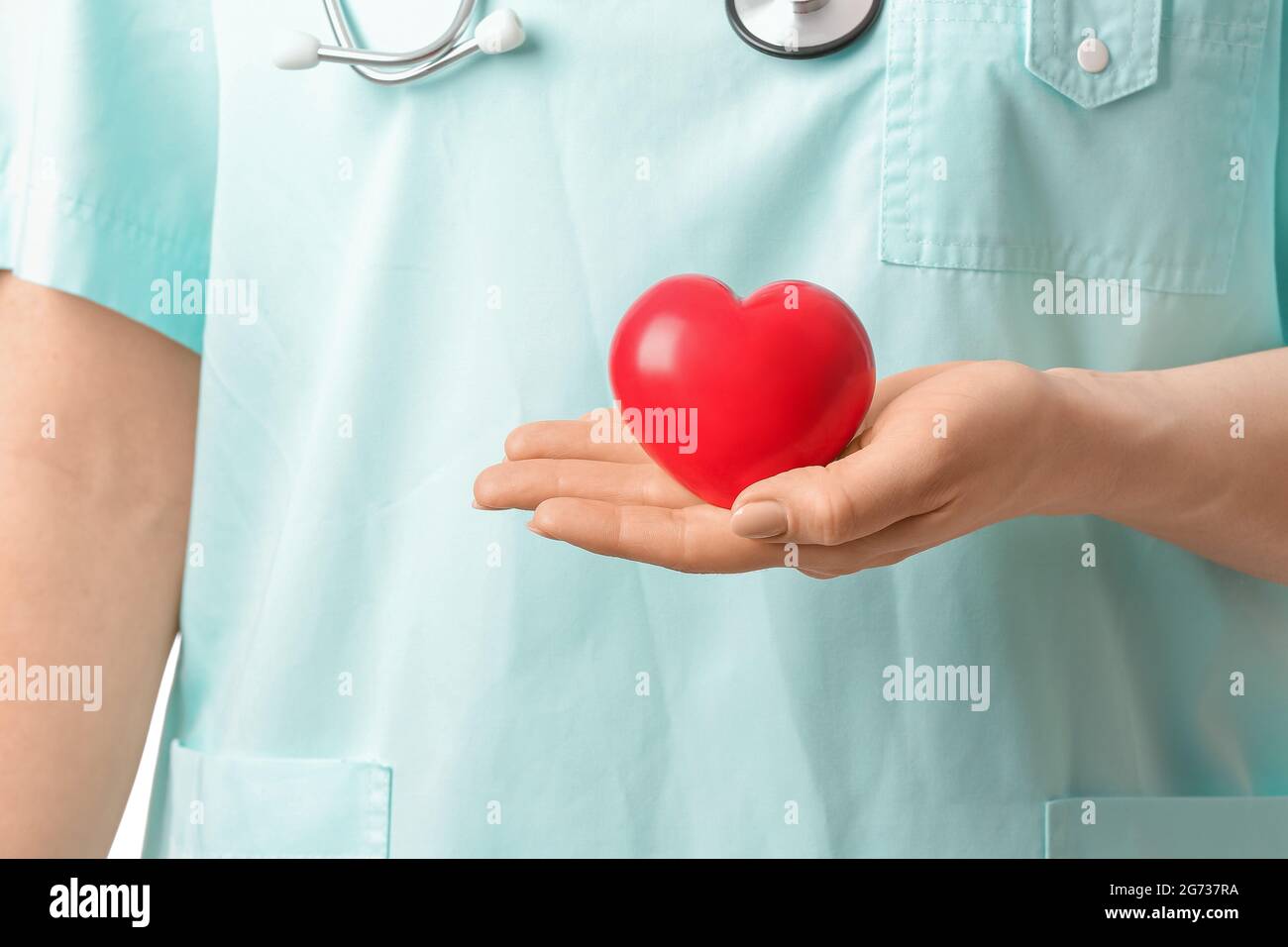 Female cardiologist with red heart, closeup Stock Photo - Alamy