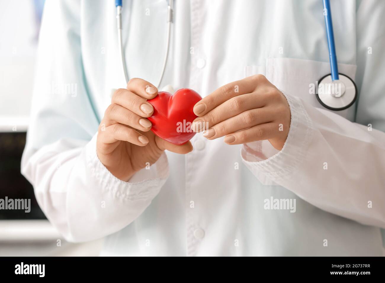 Female cardiologist with red heart, closeup Stock Photo - Alamy