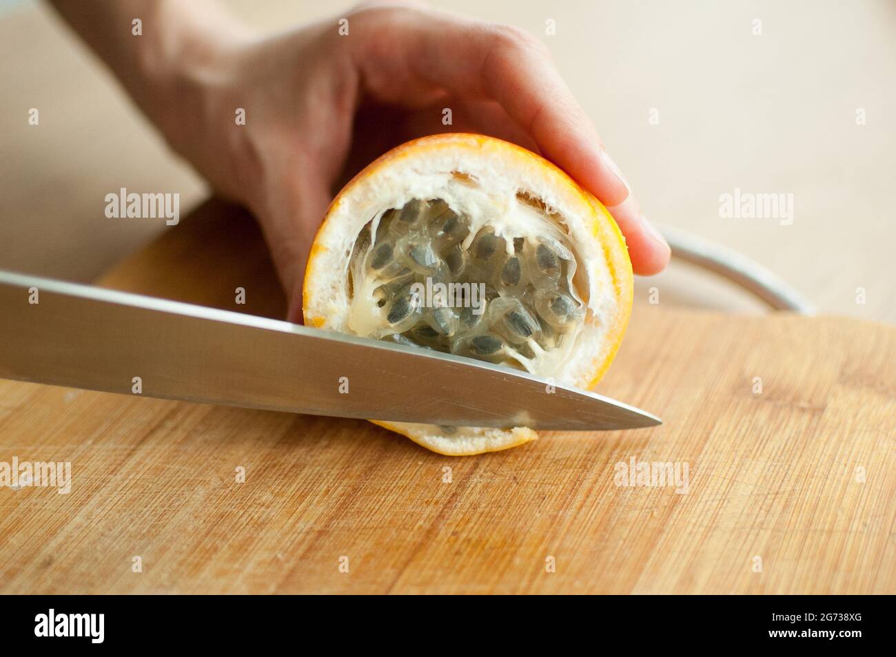 Fresh organic ripe granadilla or yellow passion fruit cut in half on a ...