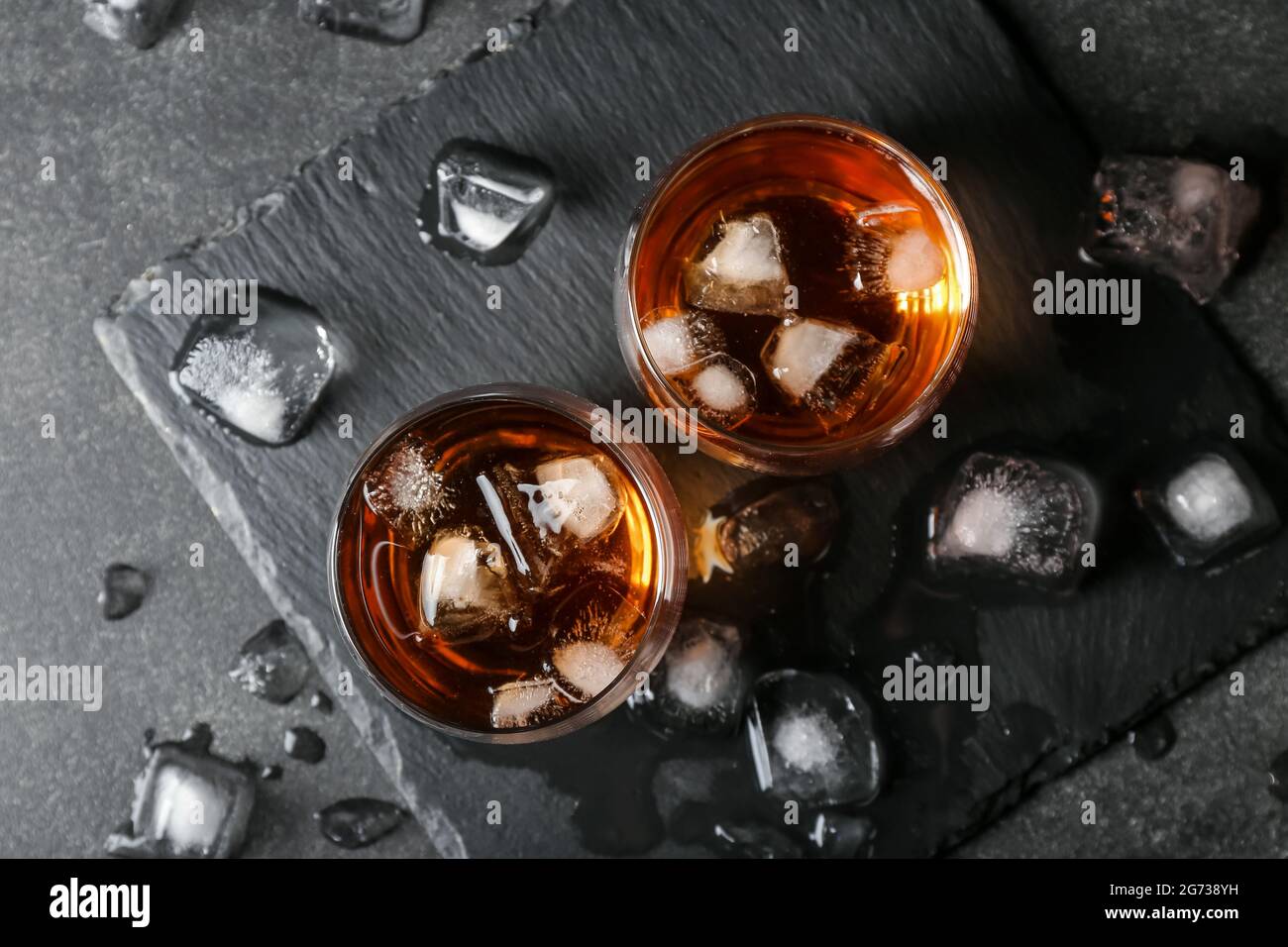 Glasses of cold whiskey on dark background Stock Photo - Alamy