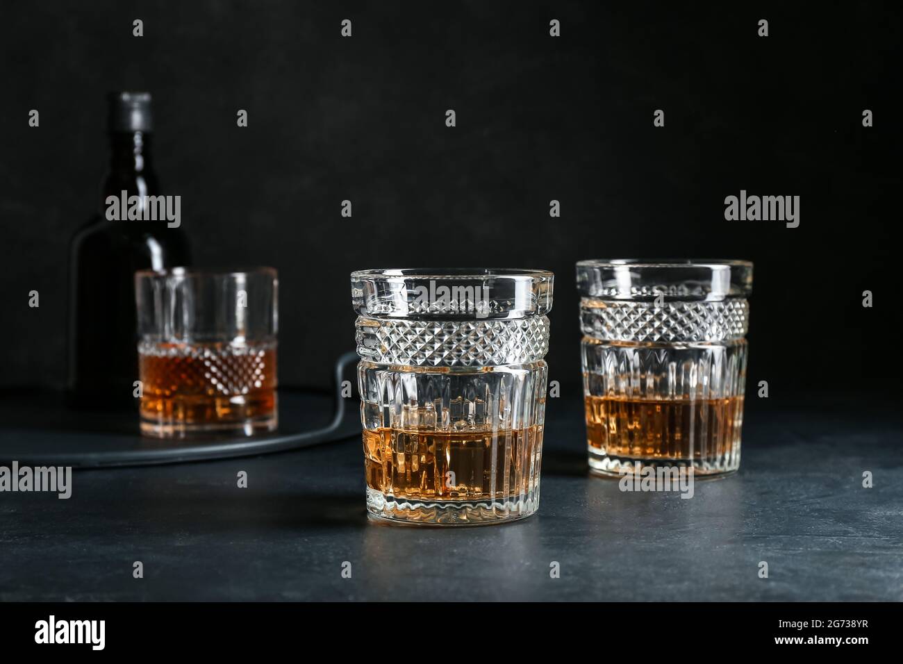 Glasses of cold whiskey on dark background Stock Photo - Alamy