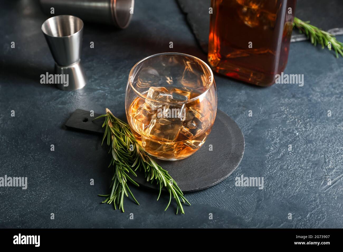 Glass of cold whiskey on dark background Stock Photo - Alamy
