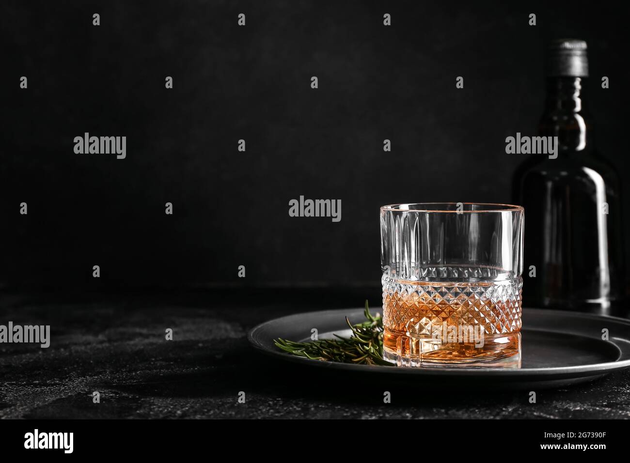 Glass of cold whiskey on dark background Stock Photo - Alamy