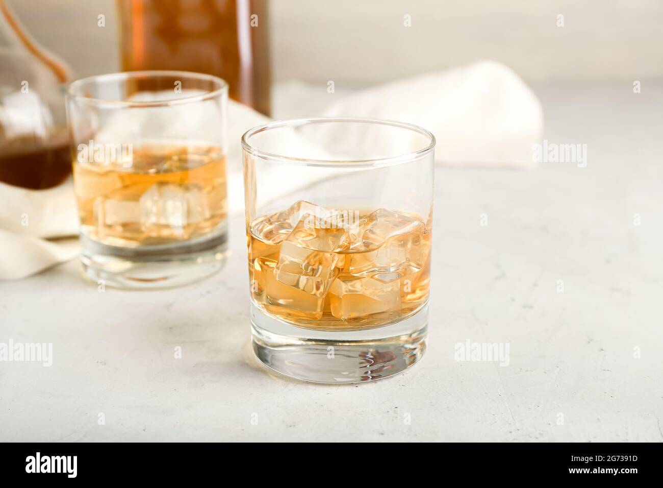 Glasses of cold whiskey on light background Stock Photo - Alamy
