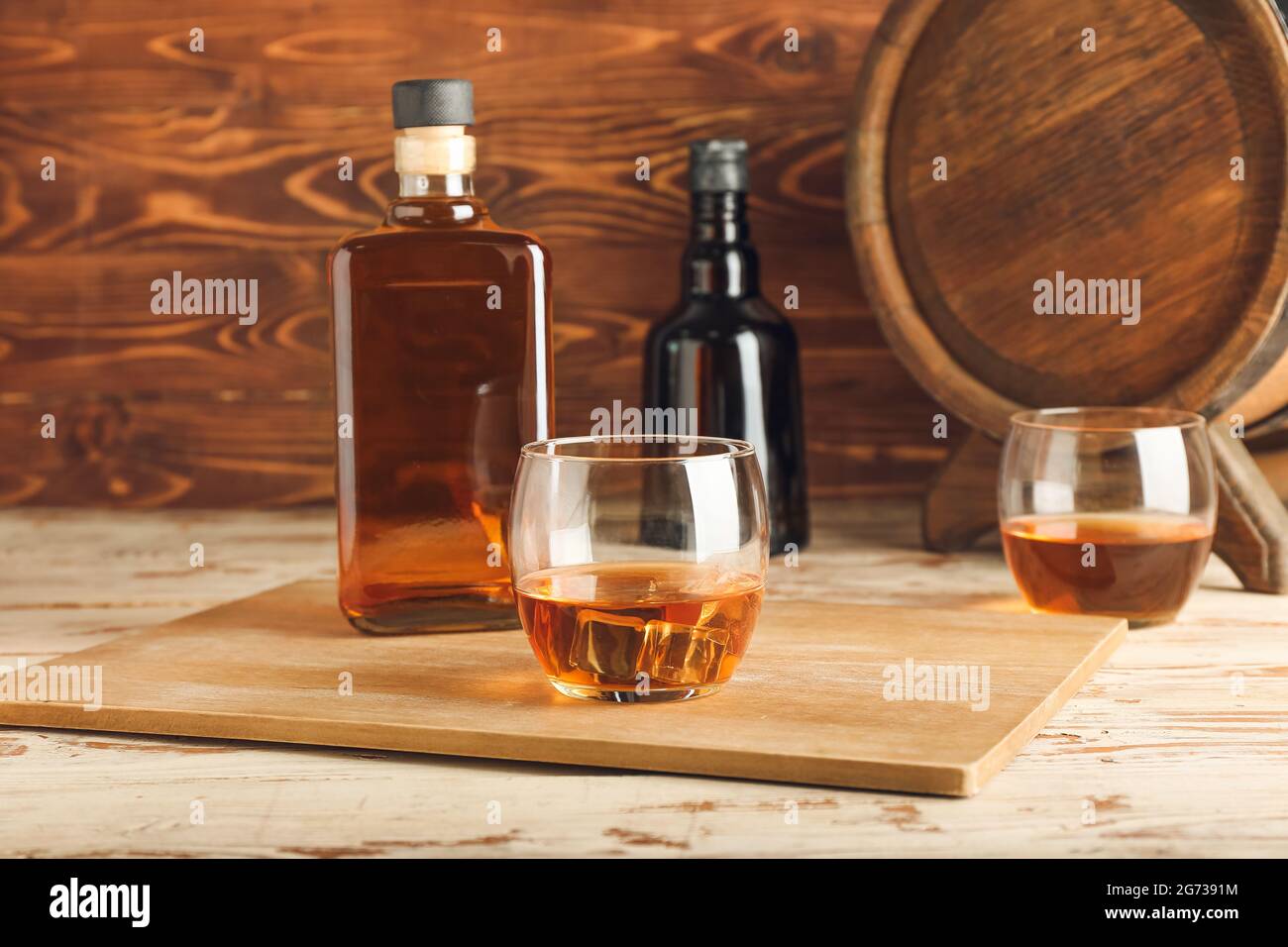 Bottle and glass of cold whiskey on table Stock Photo - Alamy