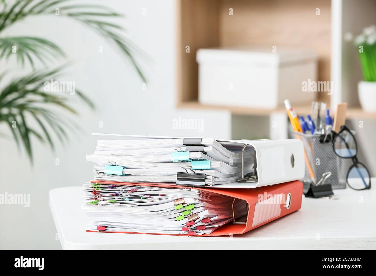 Stack of documents on table in office Stock Photo - Alamy