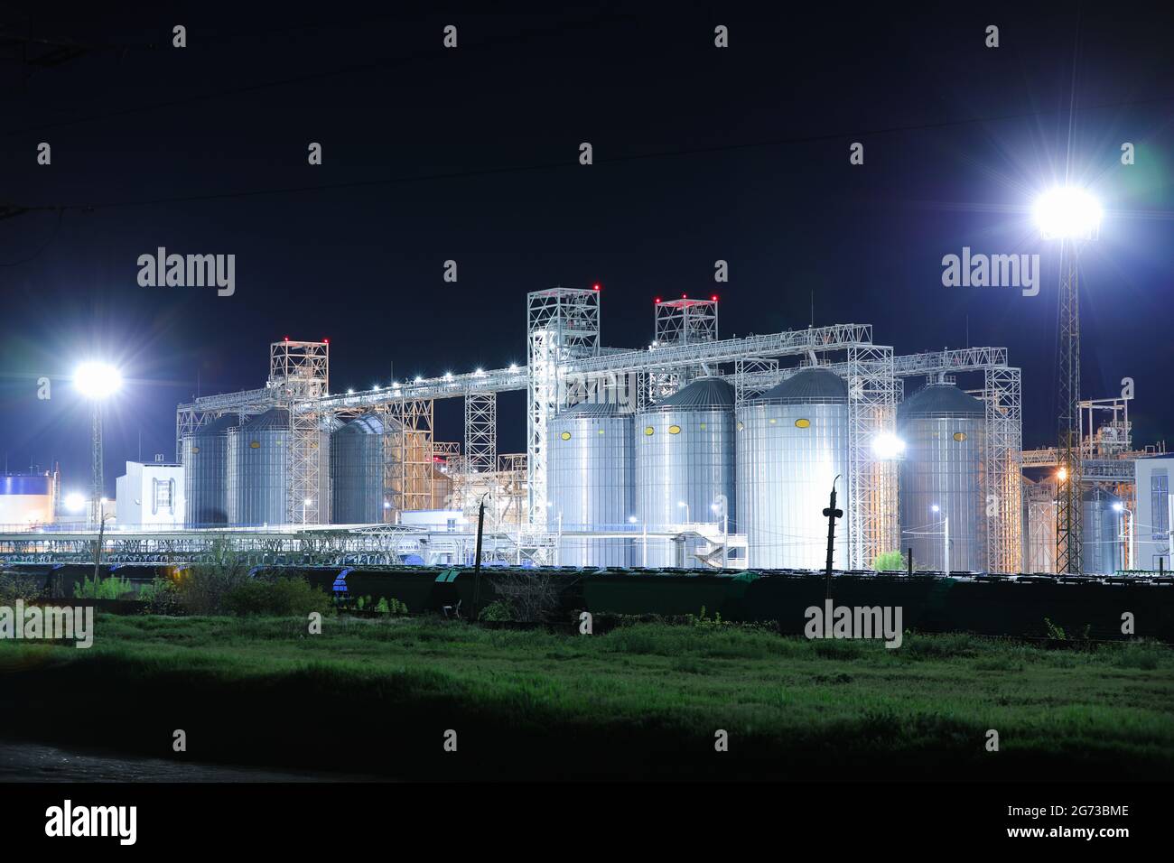 View of illuminated grain elevators at night Stock Photo - Alamy
