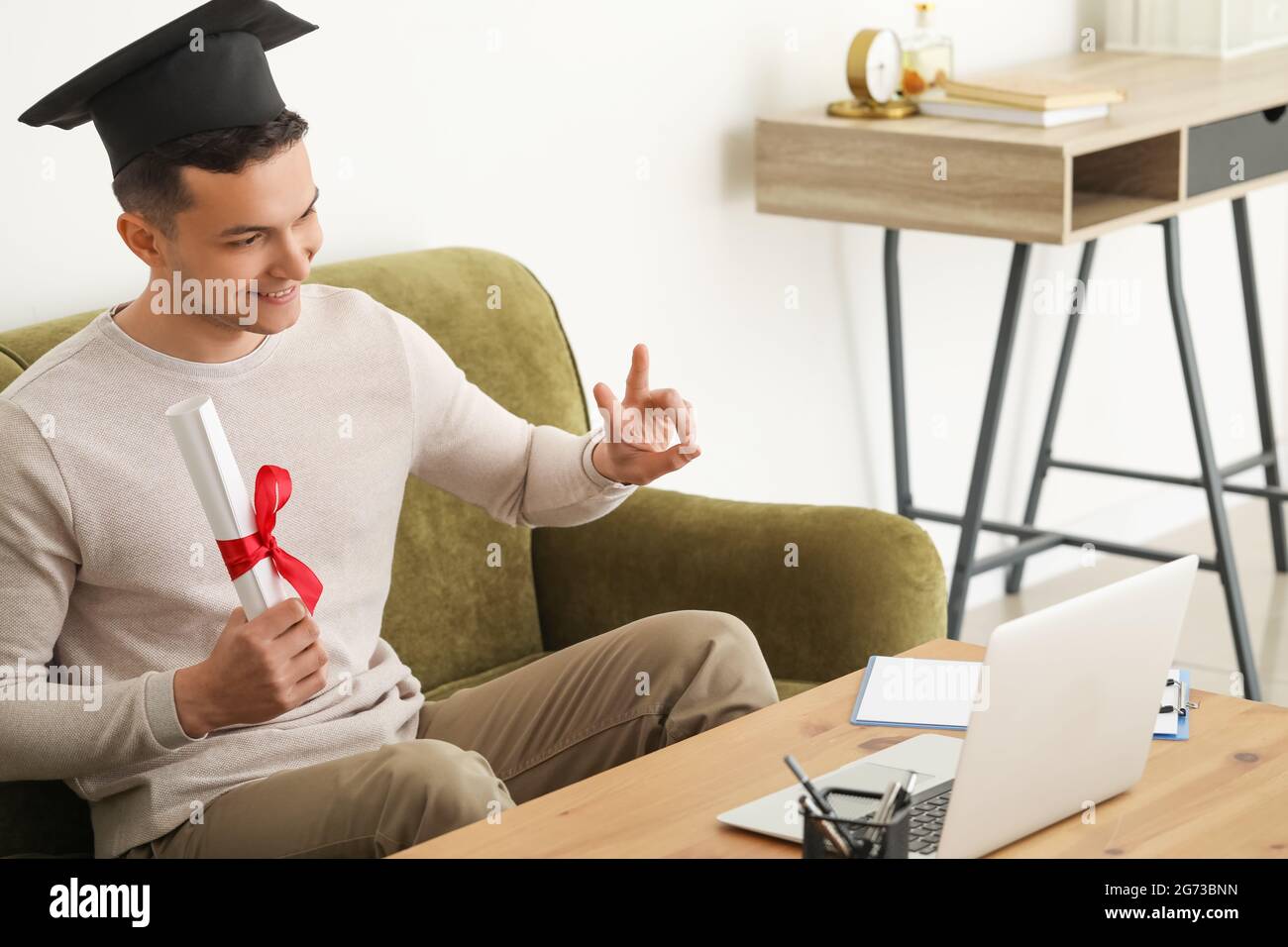 Happy male student on his graduation day at home. Concept of online ...