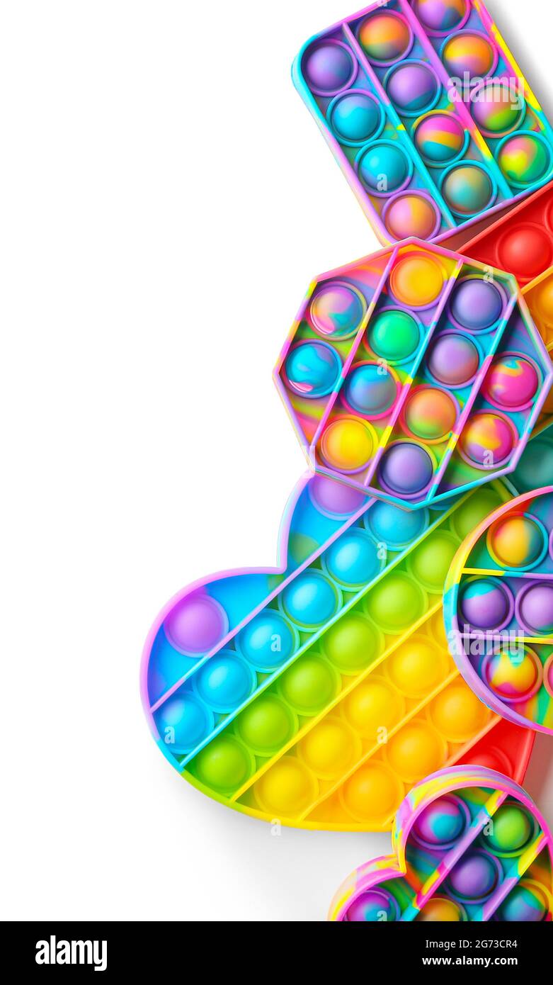 Bright fidget toys on white background Stock Photo - Alamy
