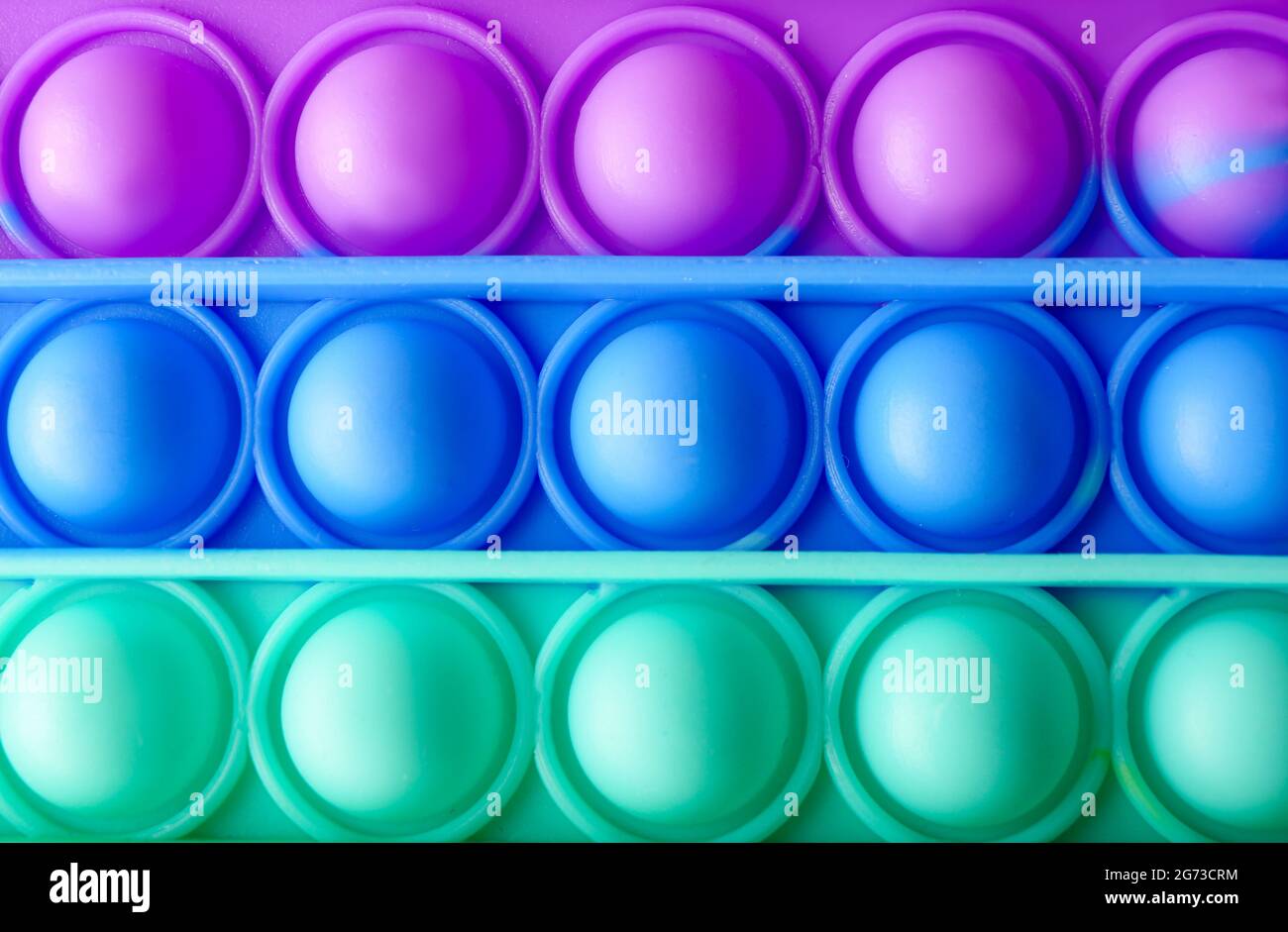 Bright fidget toy as background Stock Photo - Alamy
