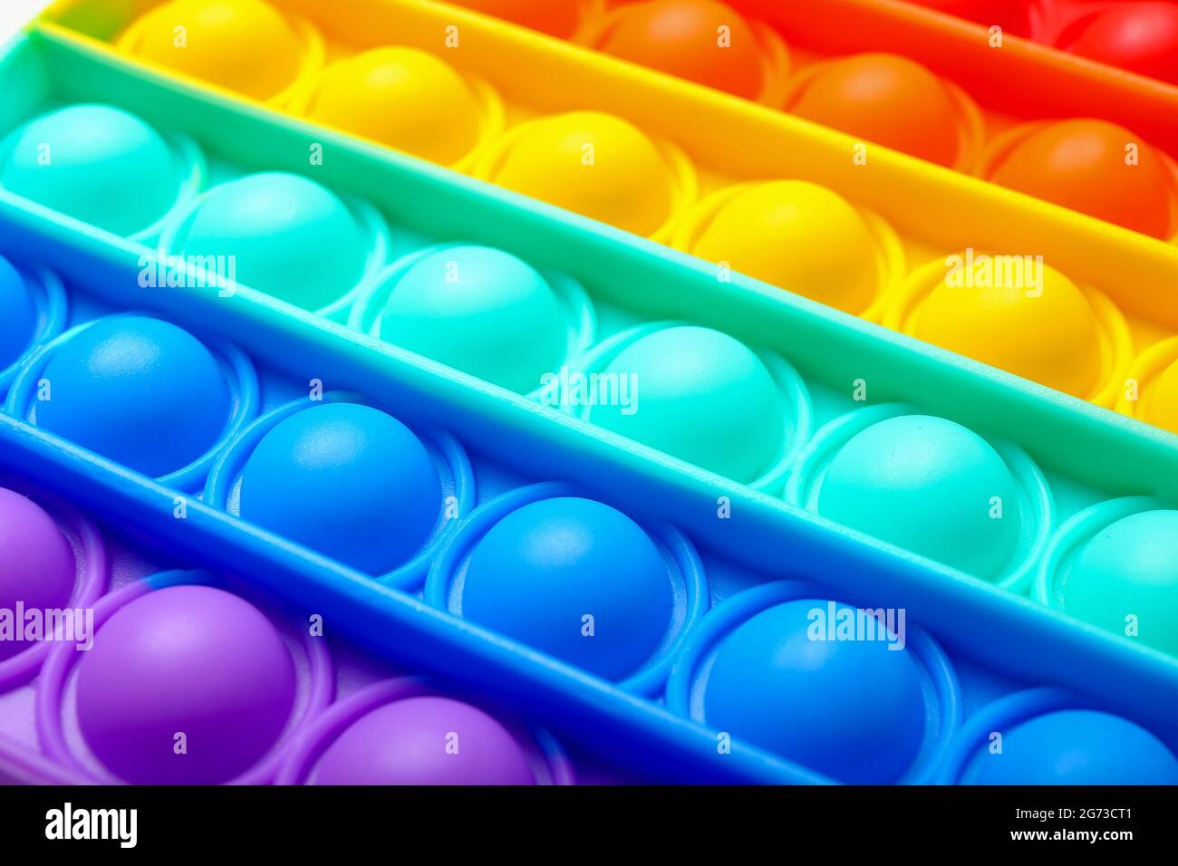 Bright fidget toy as background Stock Photo - Alamy