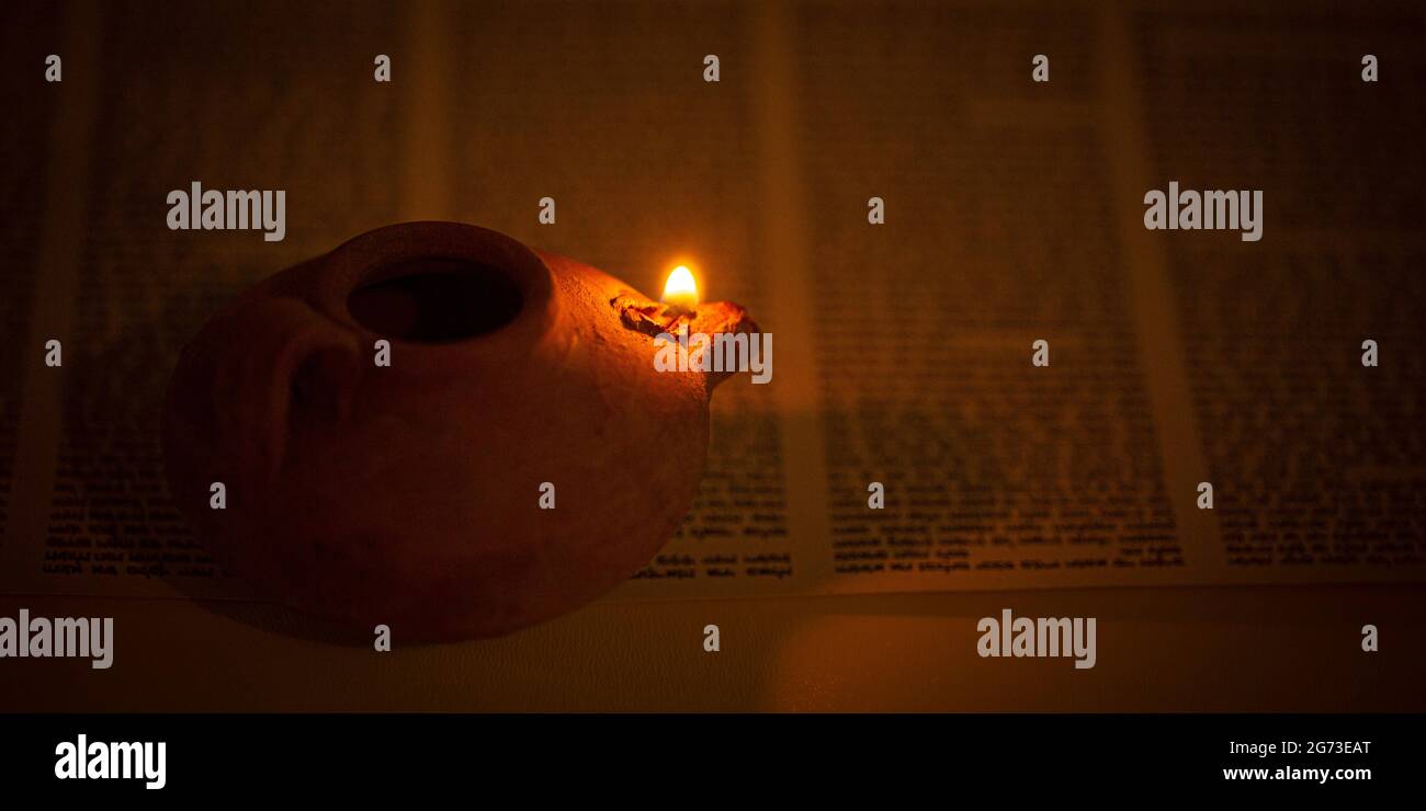 An Ancient Lamp Illuminating the Hebrew Text of the Torah Stock Photo ...