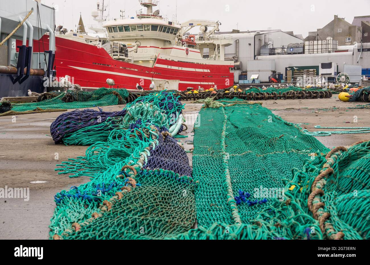 fishing trawler and nets in the port Stock Photo - Alamy
