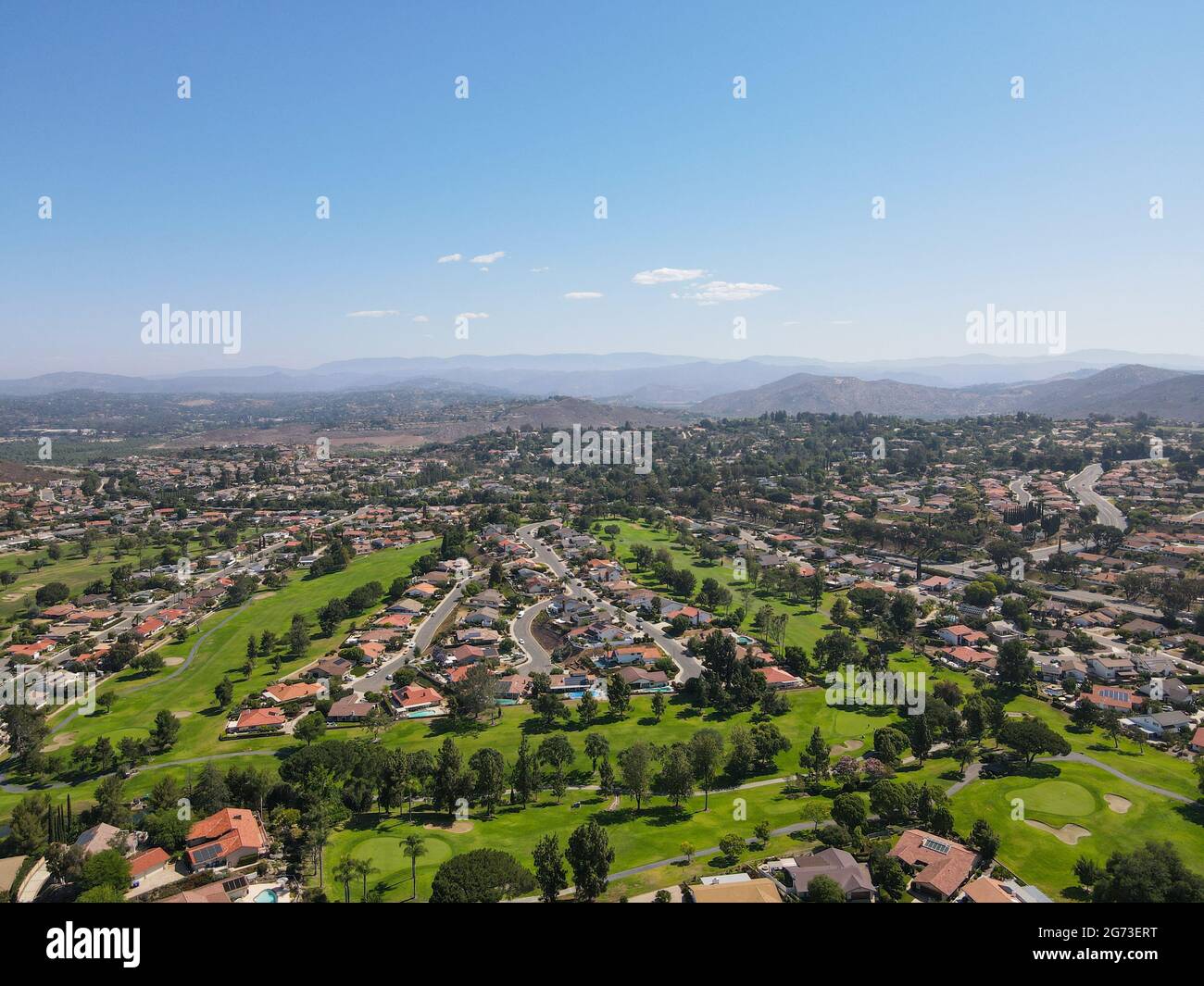 Aerial view of residential neighborhood surrounded by golf and valley ...