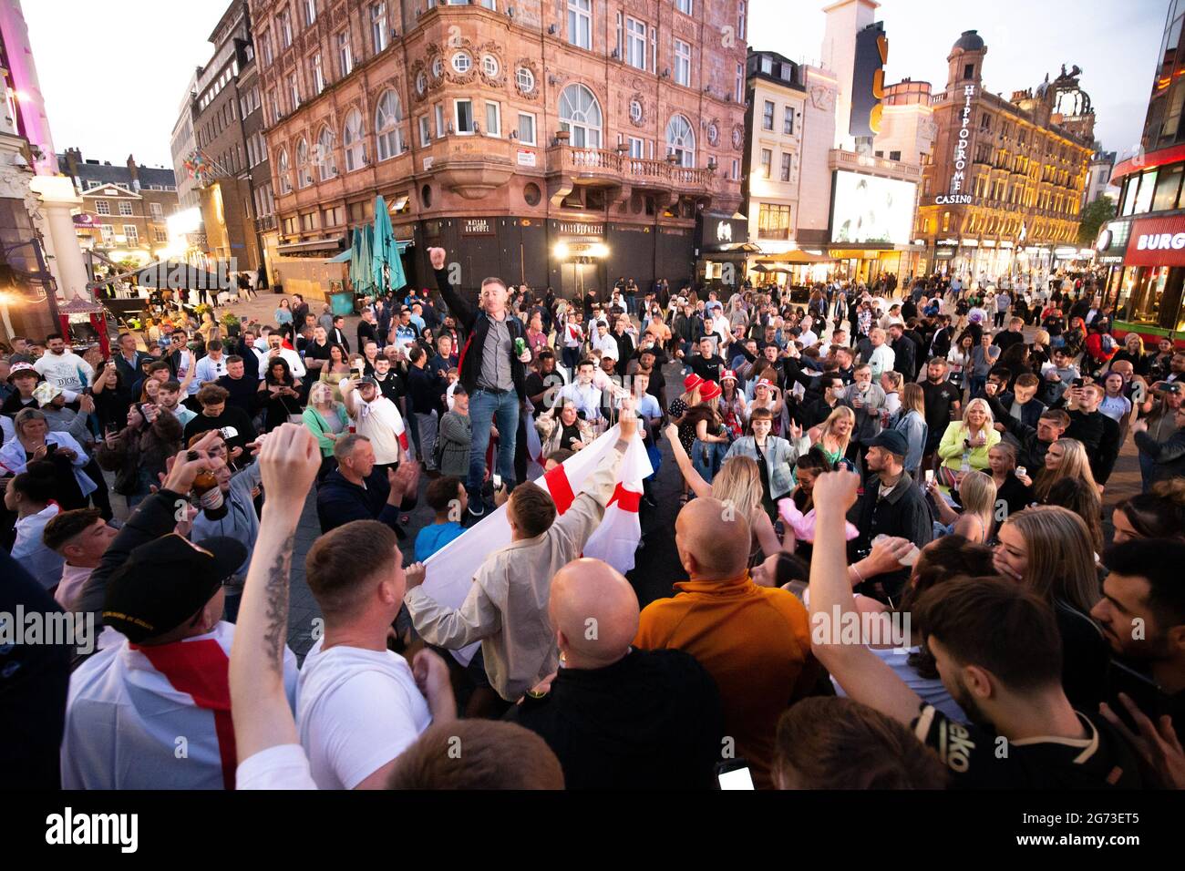 England fans singing in Leicester Square, central London, the evening ...