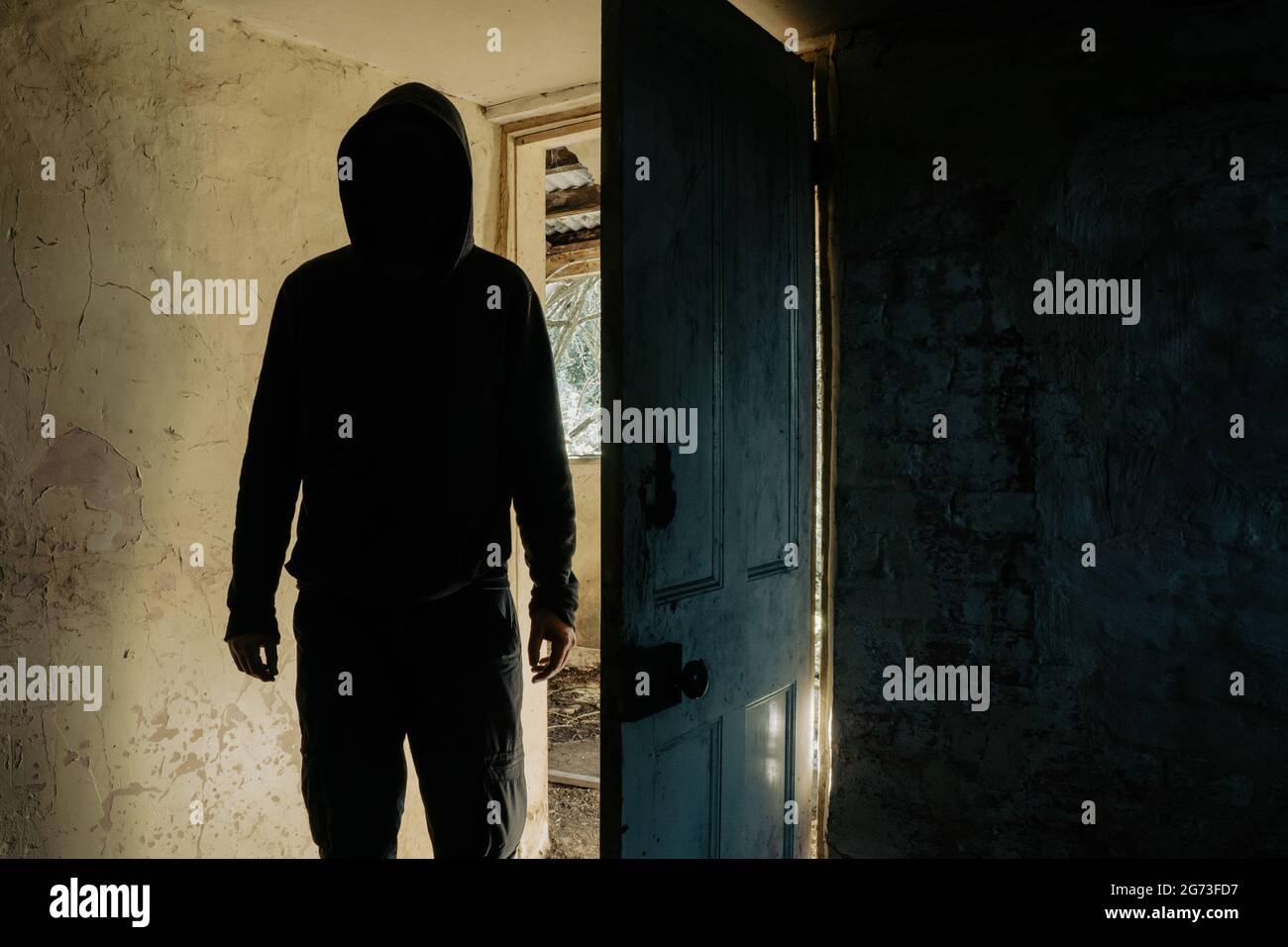 A horror concept. Of a hooded figure with no face standing in the ...