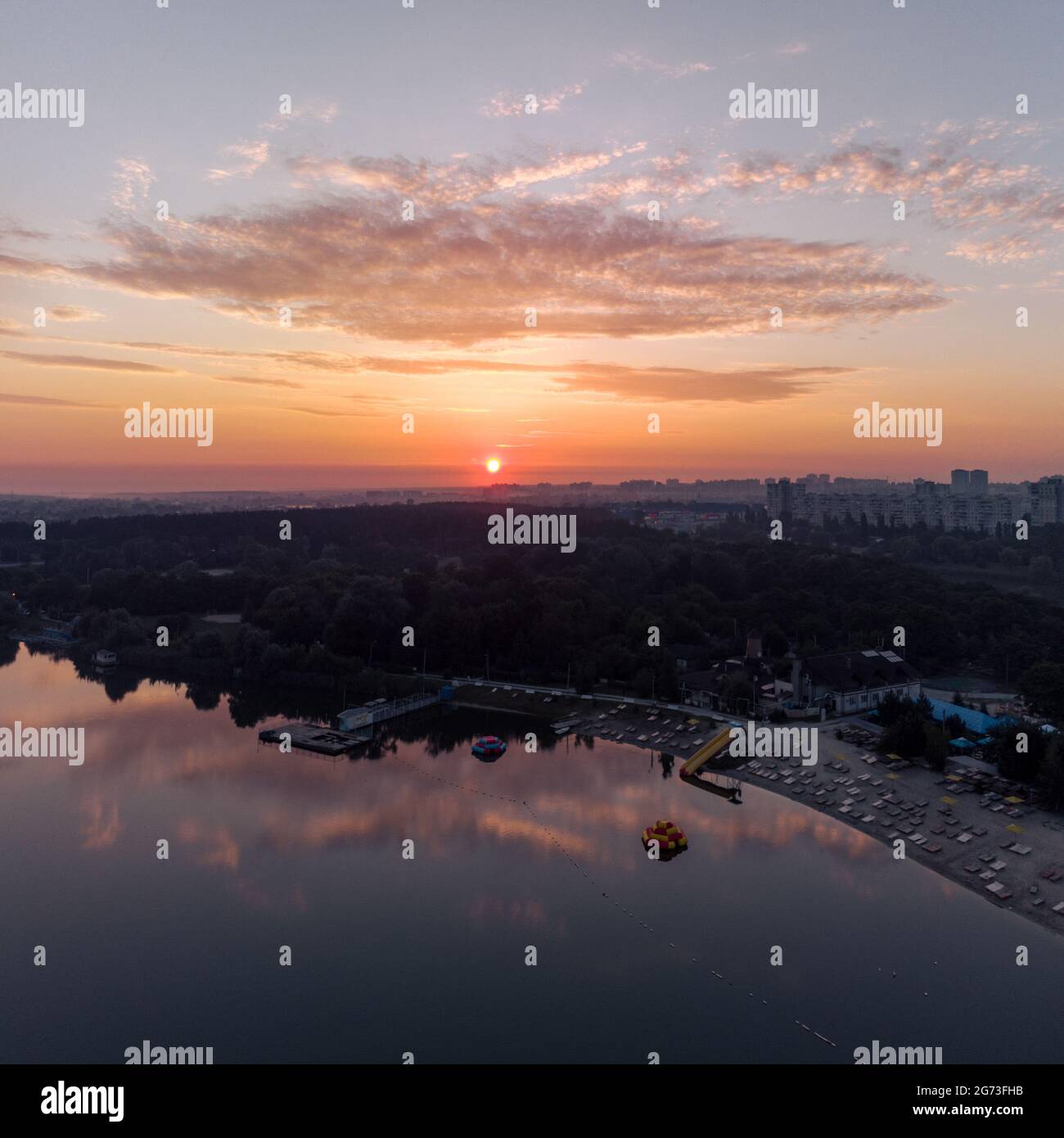 Scenic aerial sunrise with clouds reflecting in mirror water surface on ...