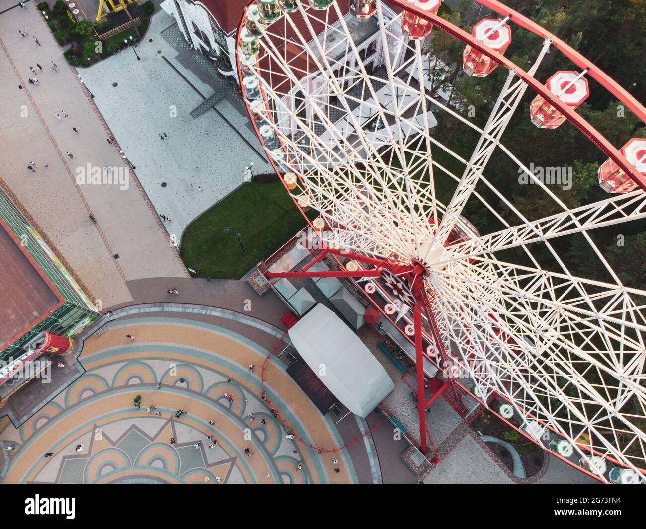 Ferris wheel spinning aerial top view in Kharkiv city center, amusement ...