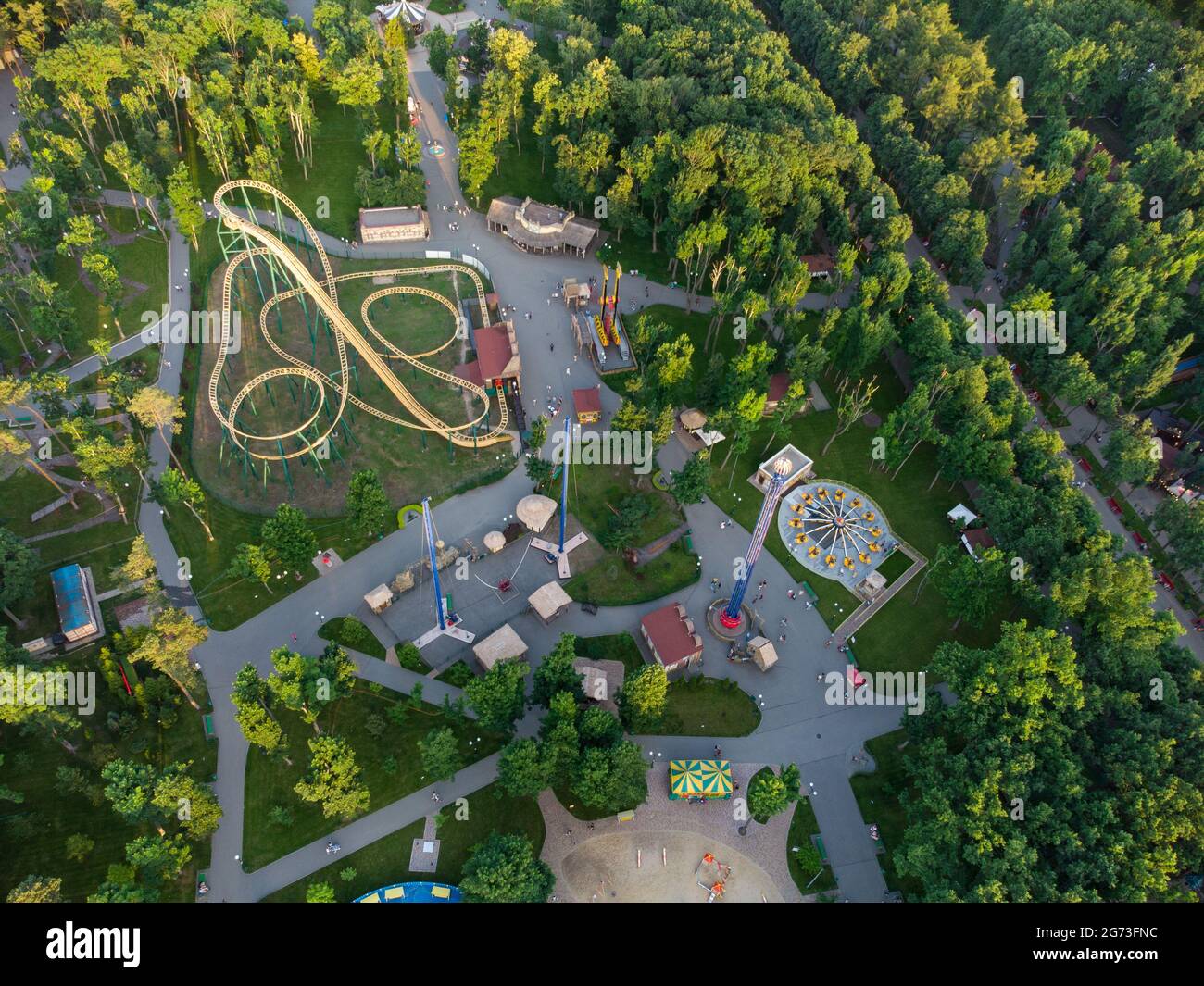 Attractions recreation area with greens in sunset light. Aerial evening ...