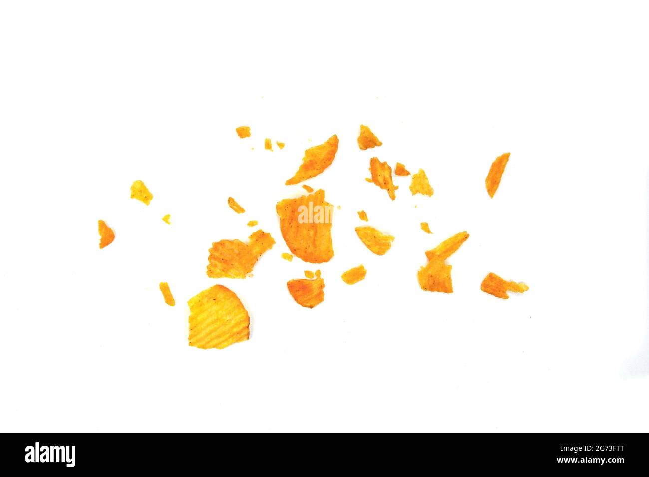 Potato chips crumbs and leftovers isolated over the white background ...