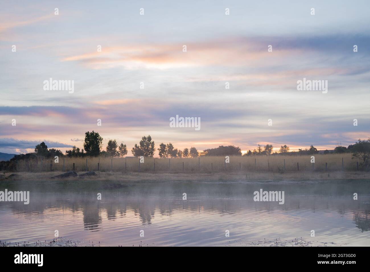 Scenic sunset at a lake bay Stock Photo - Alamy