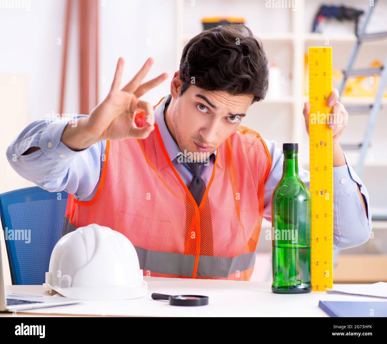 The drunk engineer working in the workshop Stock Photo - Alamy