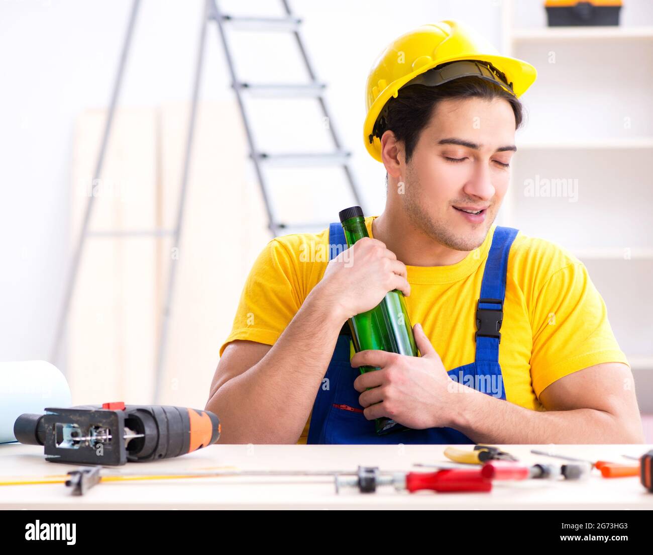 The drunk engineer working in the workshop Stock Photo - Alamy