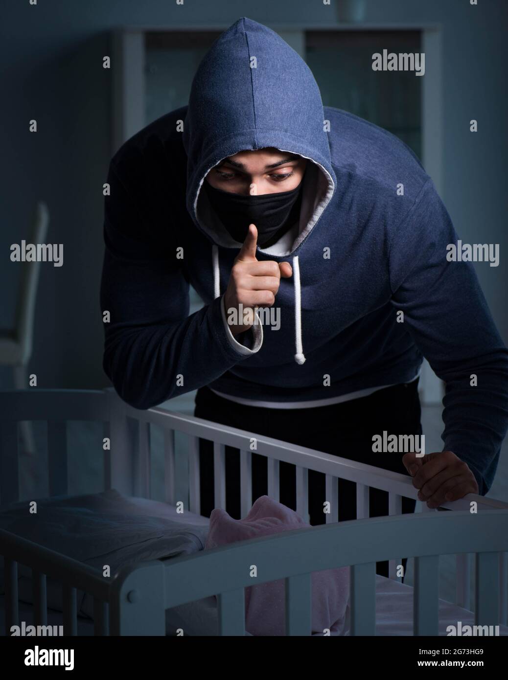 The criminal stealing baby in human child traficking concept Stock Photo - Alamy