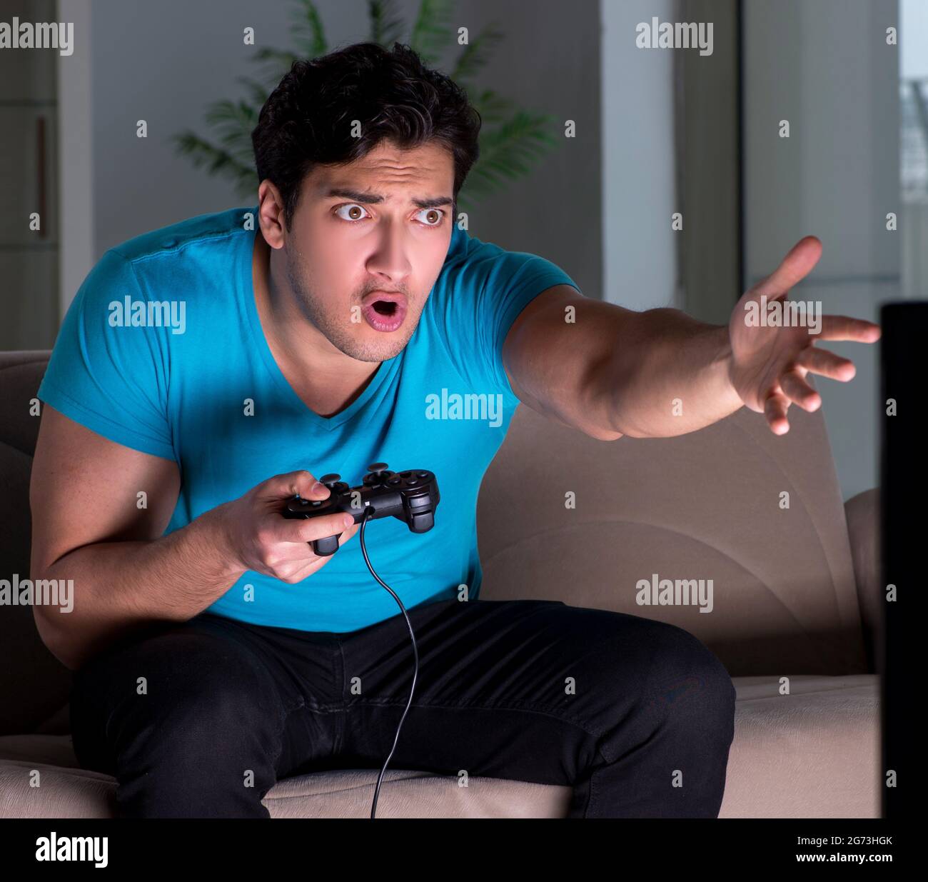 The young man playing computer games late at night Stock Photo - Alamy