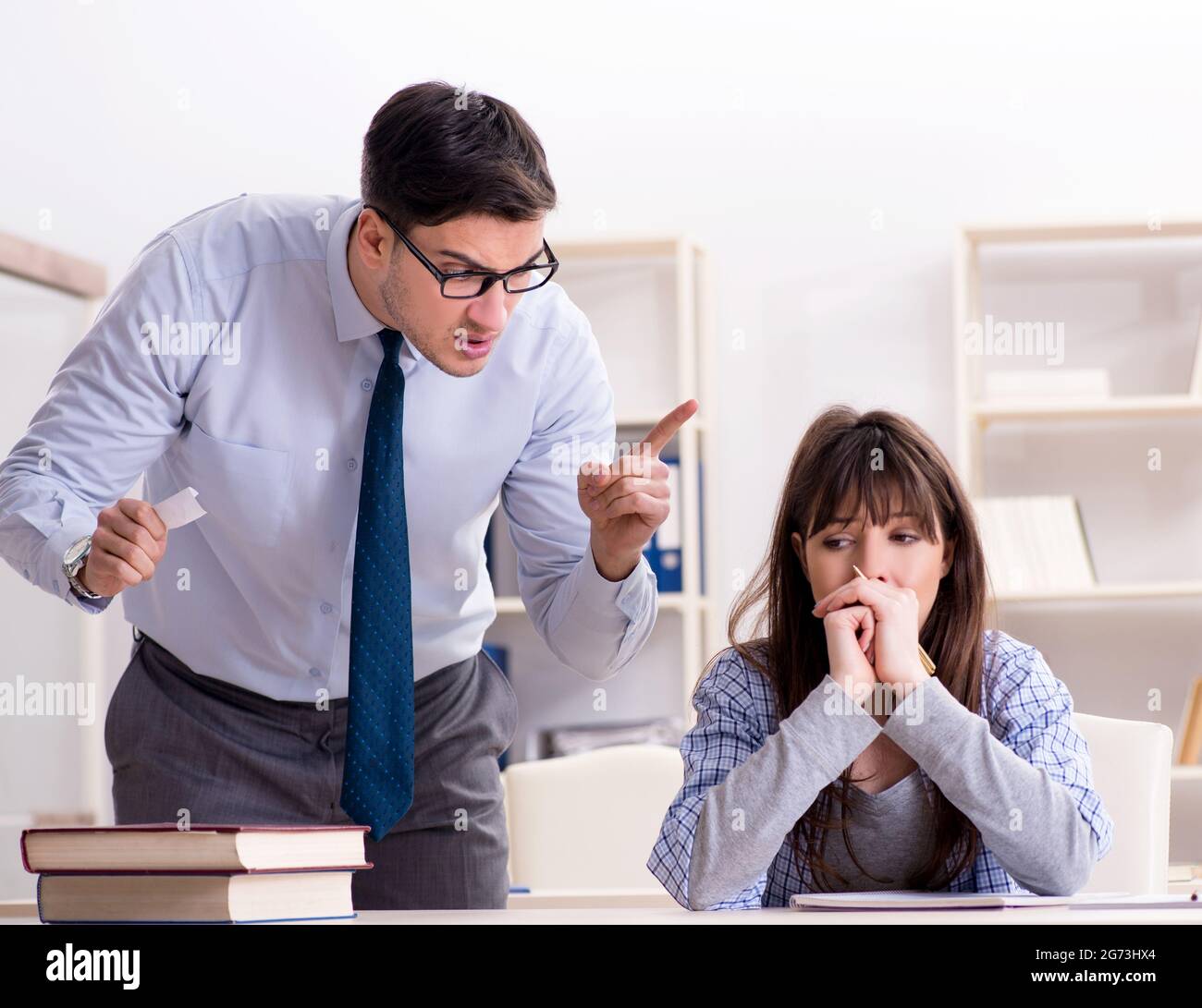 The male lecturer giving lecture to female student Stock Photo - Alamy