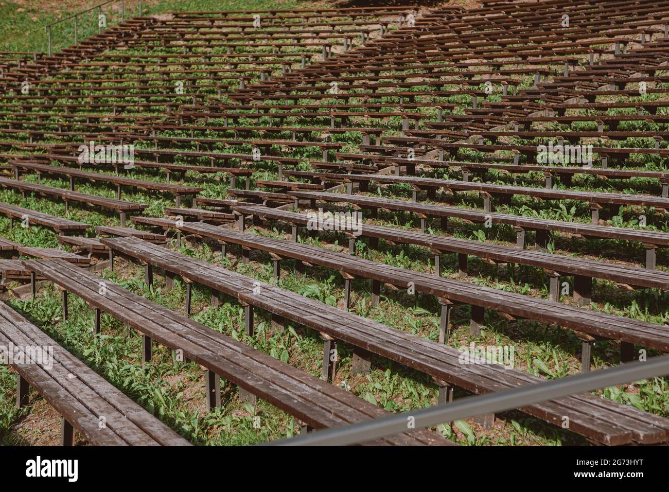 Empty wooden benches of the stadium Stock Photo - Alamy